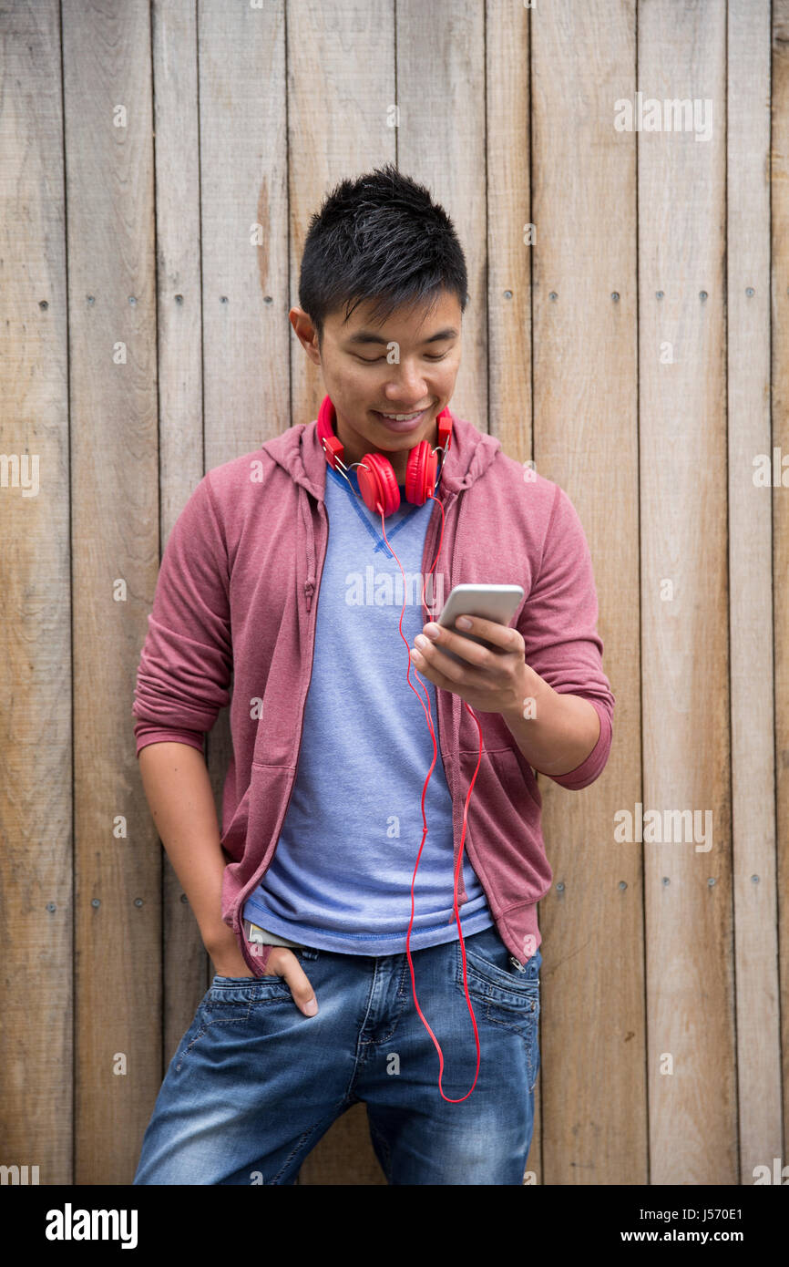 Chinese Man standing in city street using his Smart Phone Stock Photo ...
