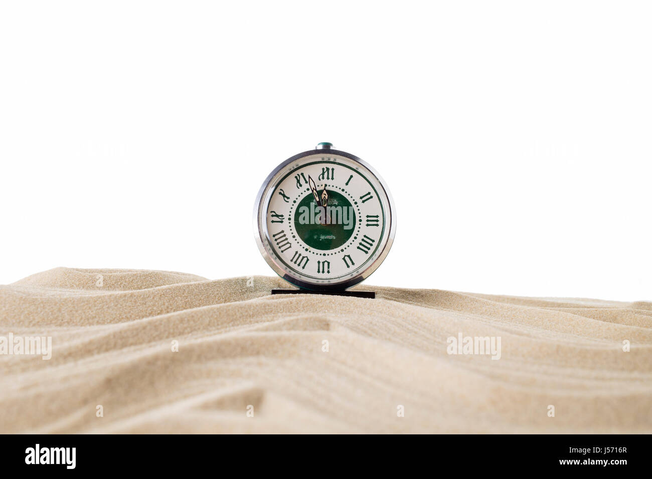 Time and sand. Old watch on the sand. Isolated on the white background ...