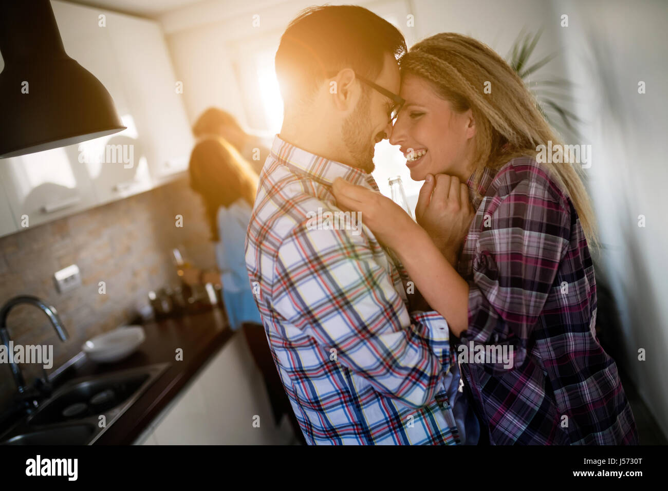 Romantic couple in love spending time together in kitchen Stock Photo ...