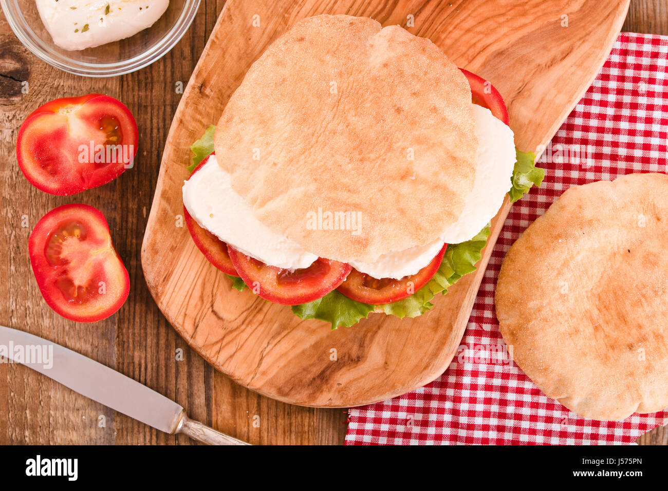Puccia bread with mozzarella and tomato Stock Photo - Alamy