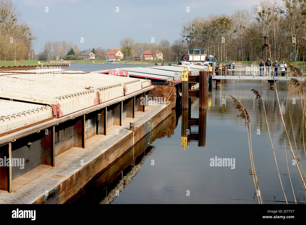 reed channel mirroring freighter freight river water rowing boat ...
