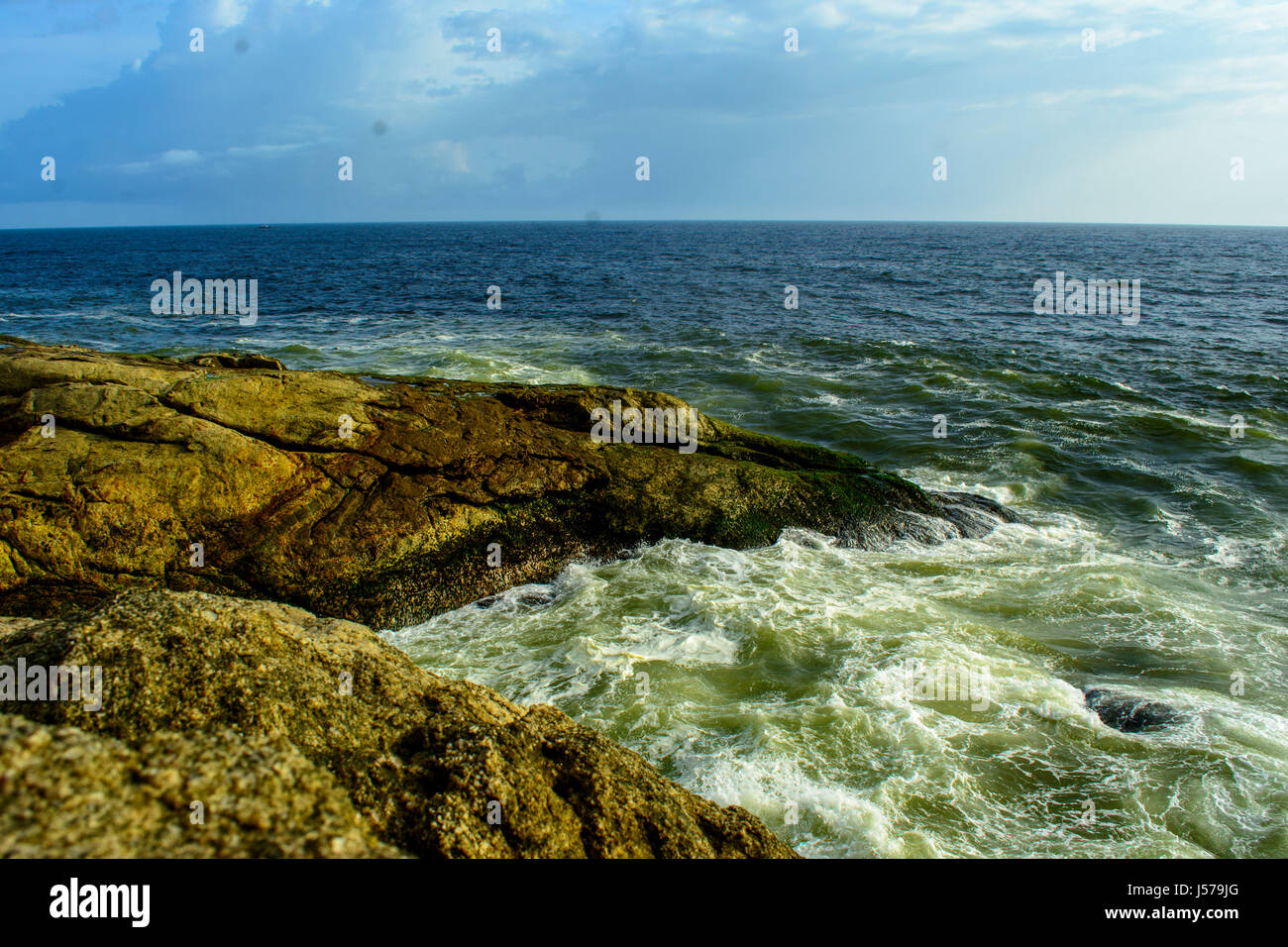Waves washing ashore over rocks, Indian Ocean Stock Photo - Alamy