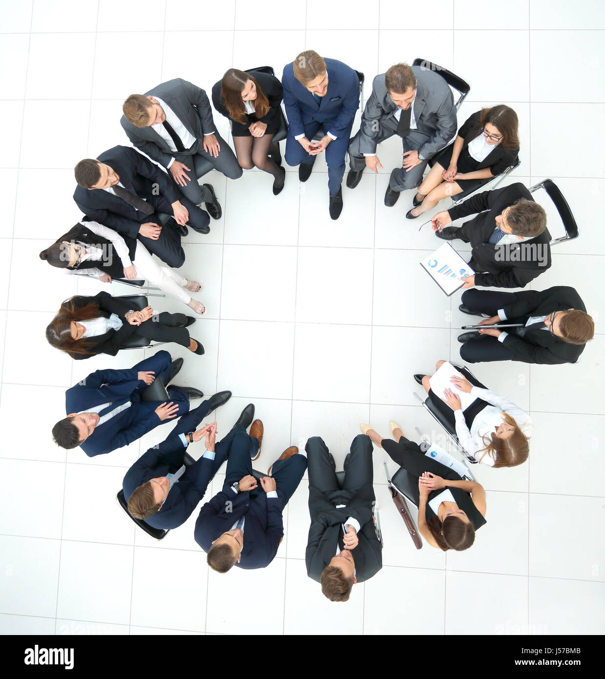 Happy business team pointing at something Stock Photo - Alamy