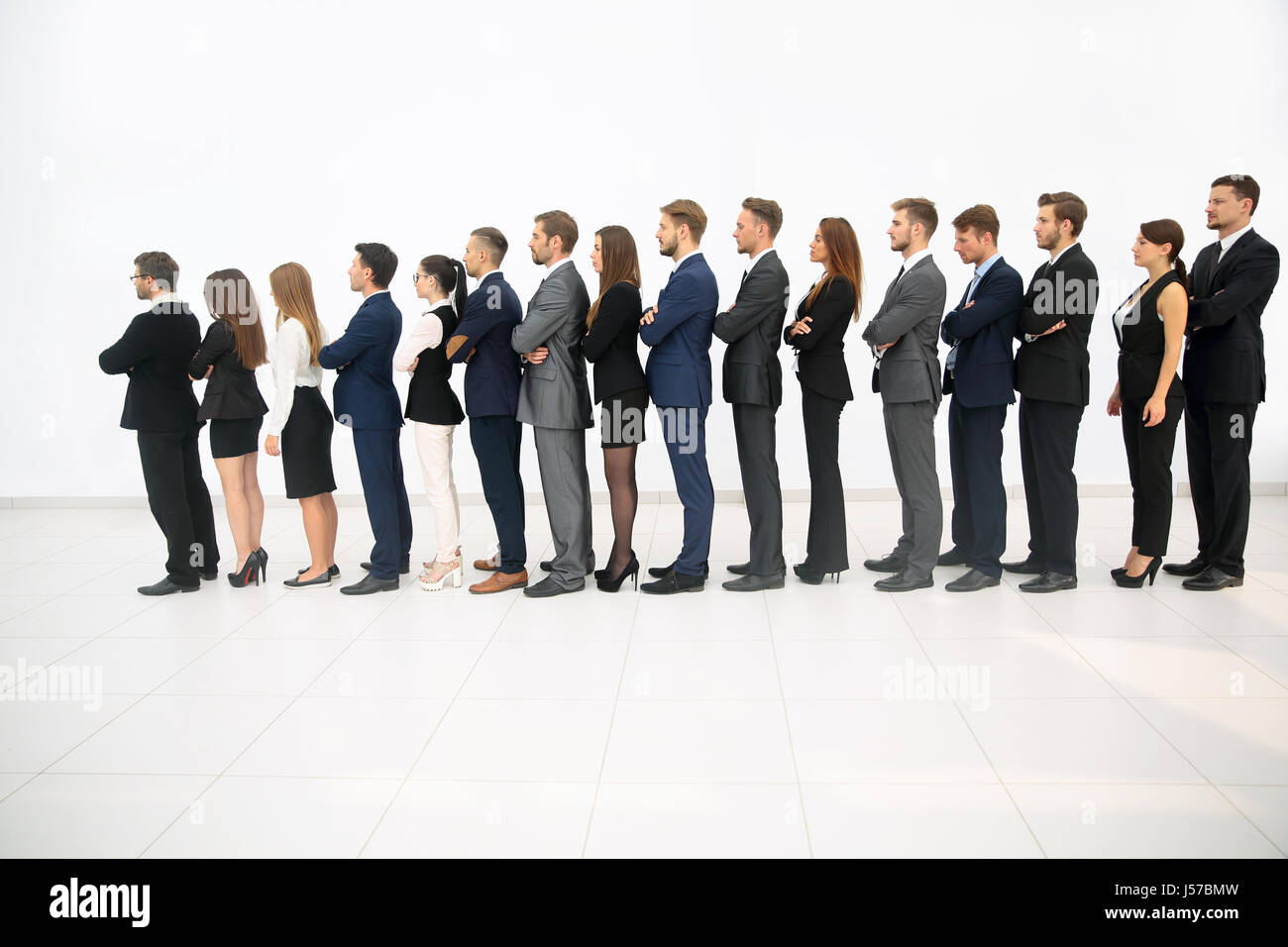 Smiling business people standing together in line in a modern of Stock ...