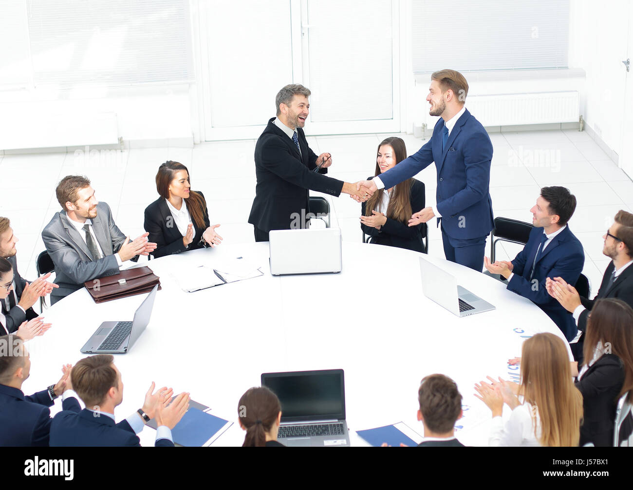 Shake hands after successful negotiations. Round Table Stock Photo - Alamy