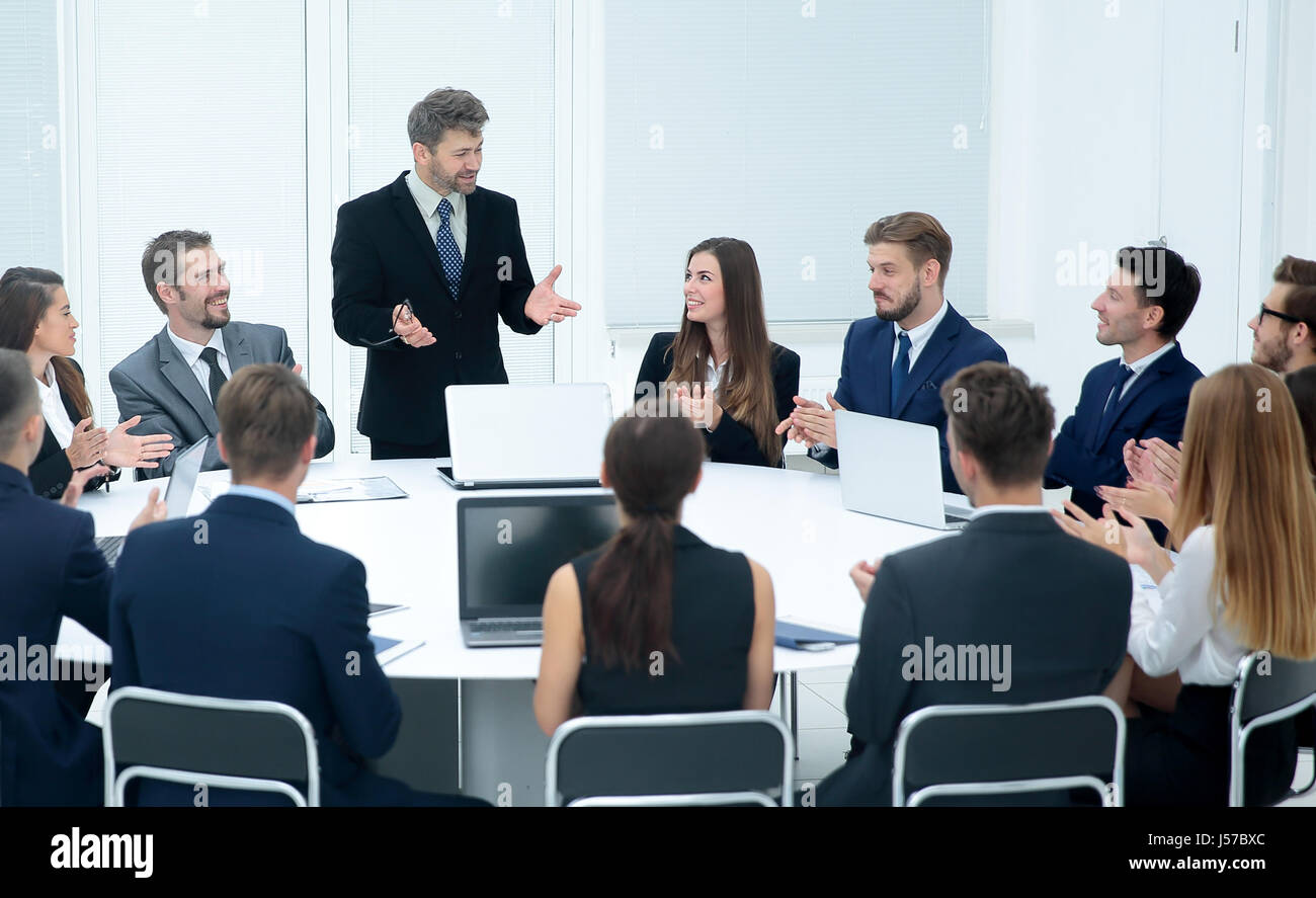 Business group greets leader with clapping and smiling Stock Photo - Alamy