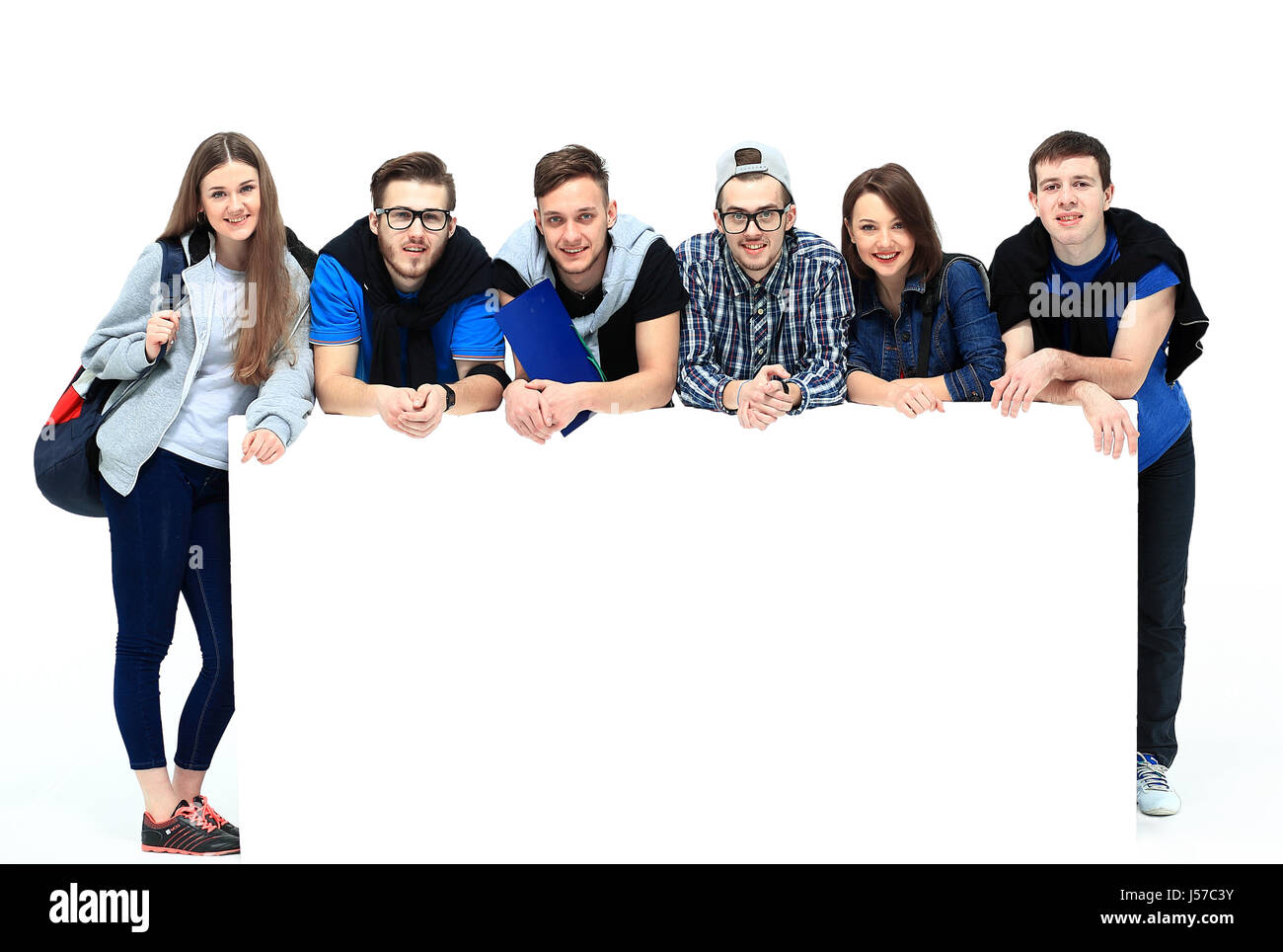 Full length portrait of confident college students displaying blank ...