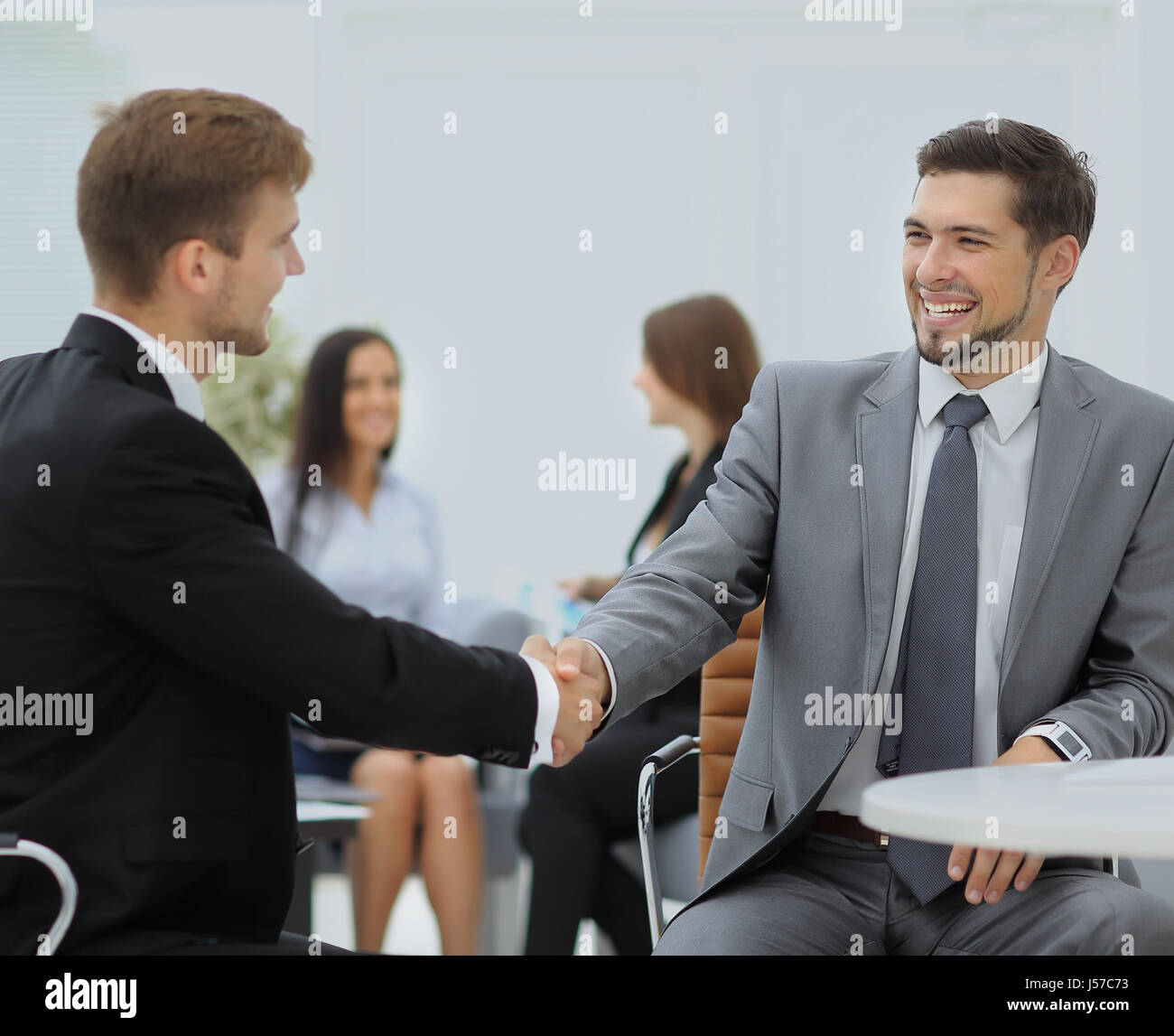 Business meeting at the table with handshake Stock Photo - Alamy