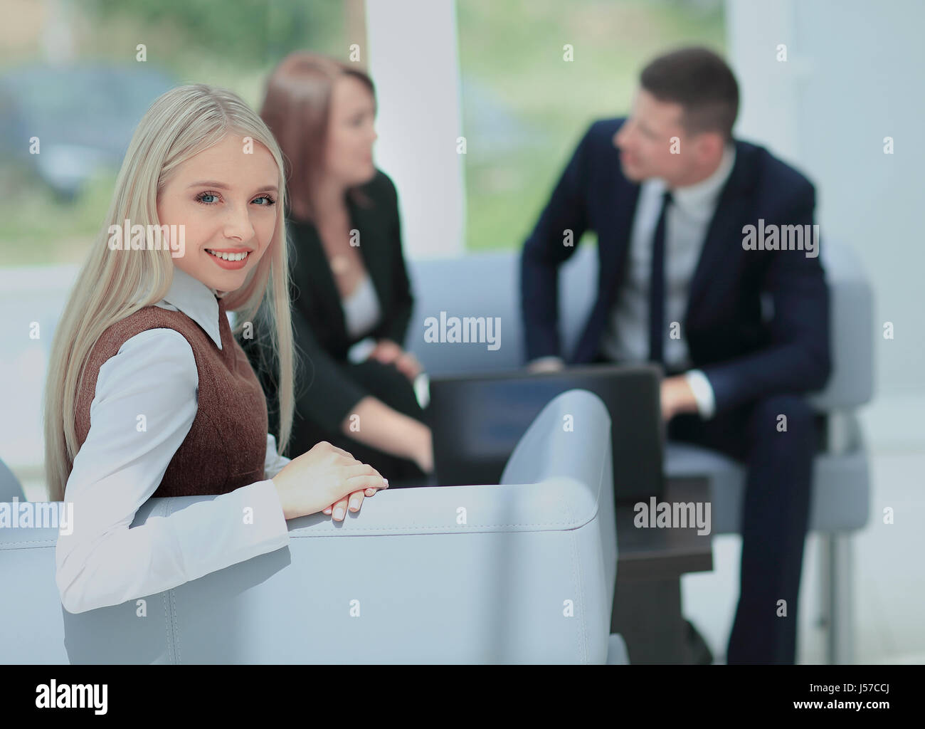 Portrait of happy businesswoman with two colleagues interacting Stock ... Portrait of happy businesswoman with two colleagues interacting Stock ...