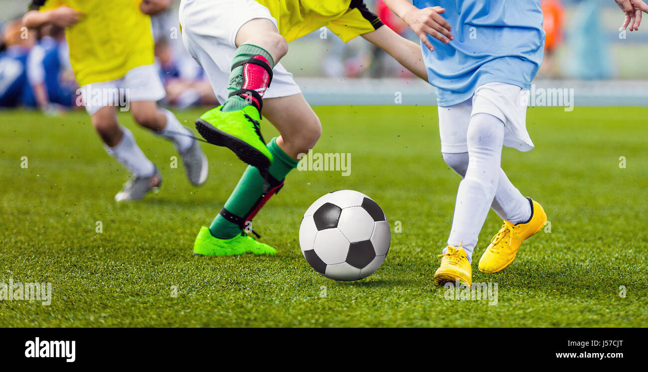 Children Football Players Running After the Ball. Kids Sport Duel ...