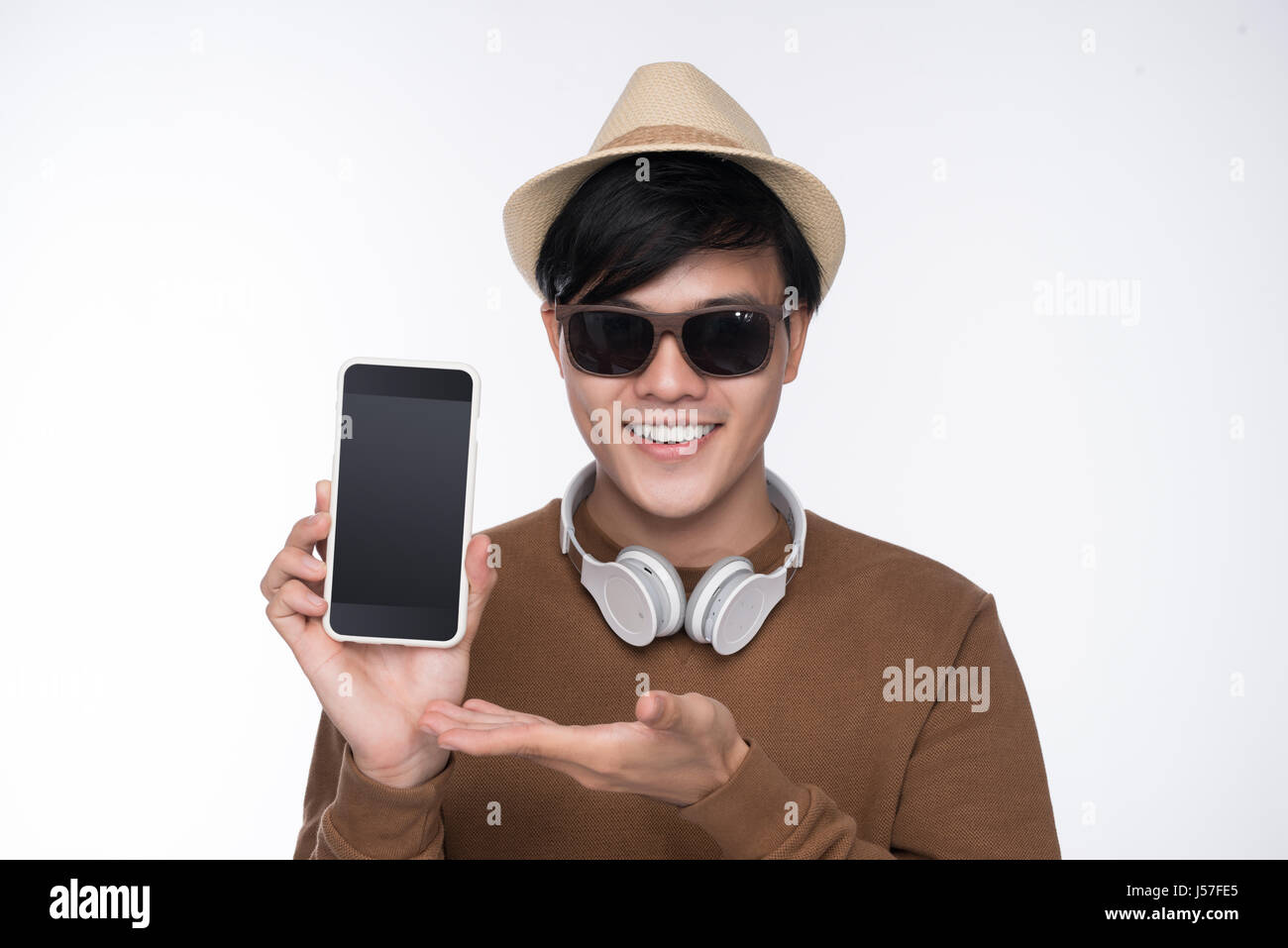 Smart casual asian man seated on chair, showing smartphone screen in ...