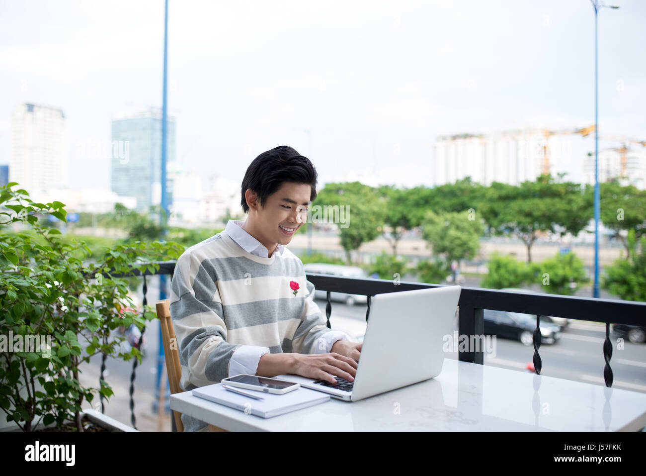 Young asian student using laptop at the city cafe shop Stock Photo - Alamy