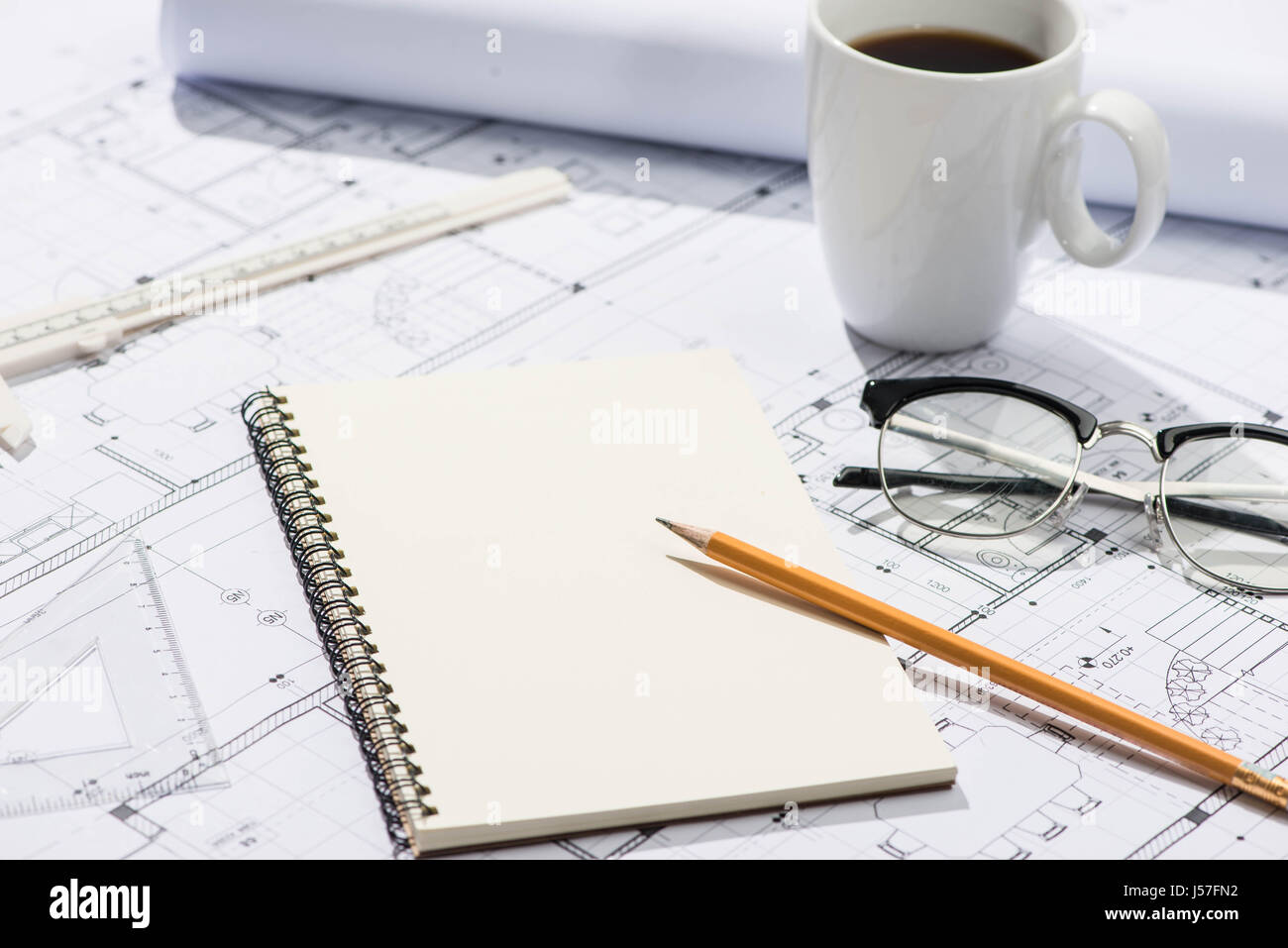 Construction projects. Planning. Open blueprints with a pencil and ...