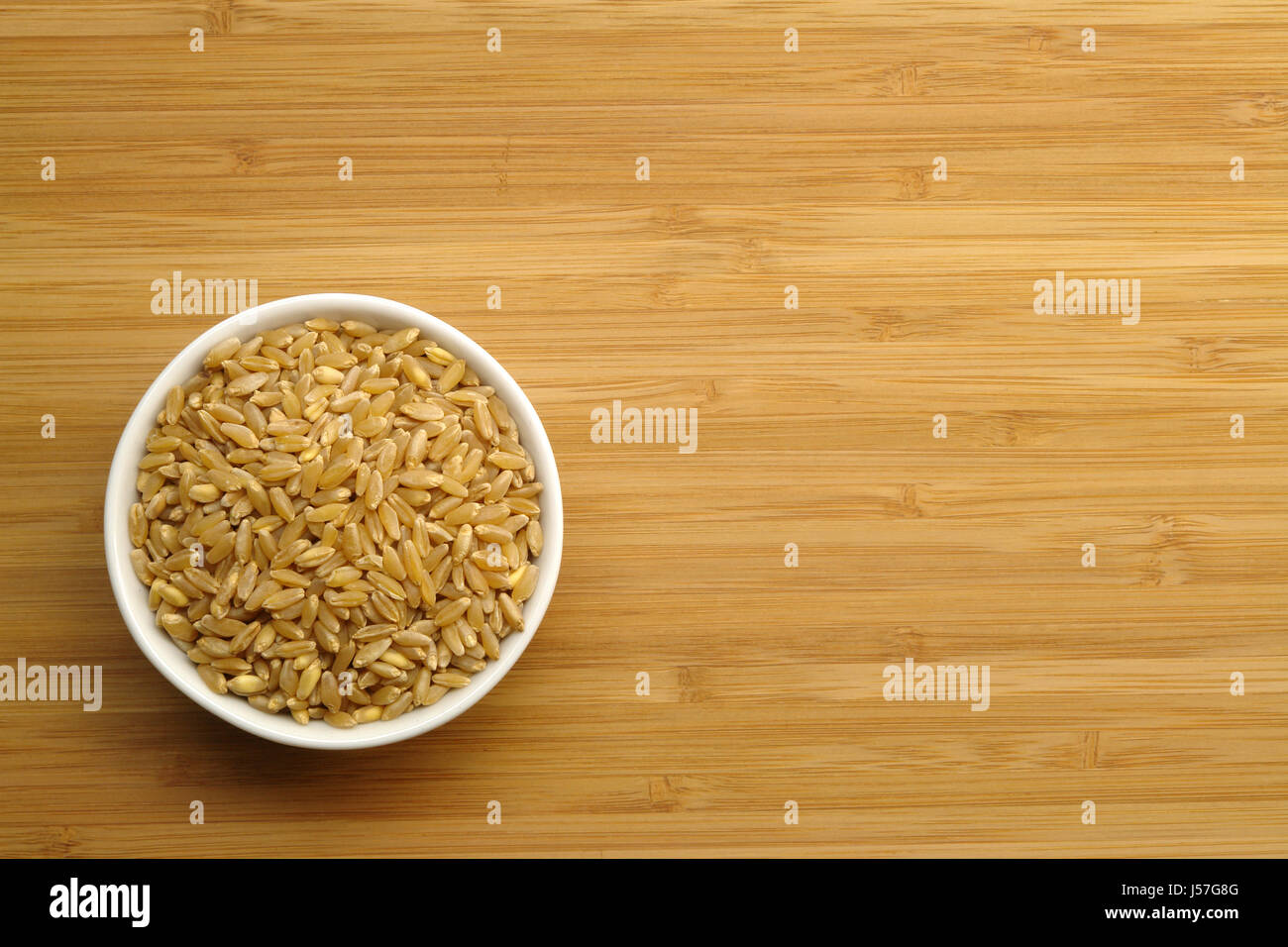 Cup of wheat on wood Stock Photo - Alamy