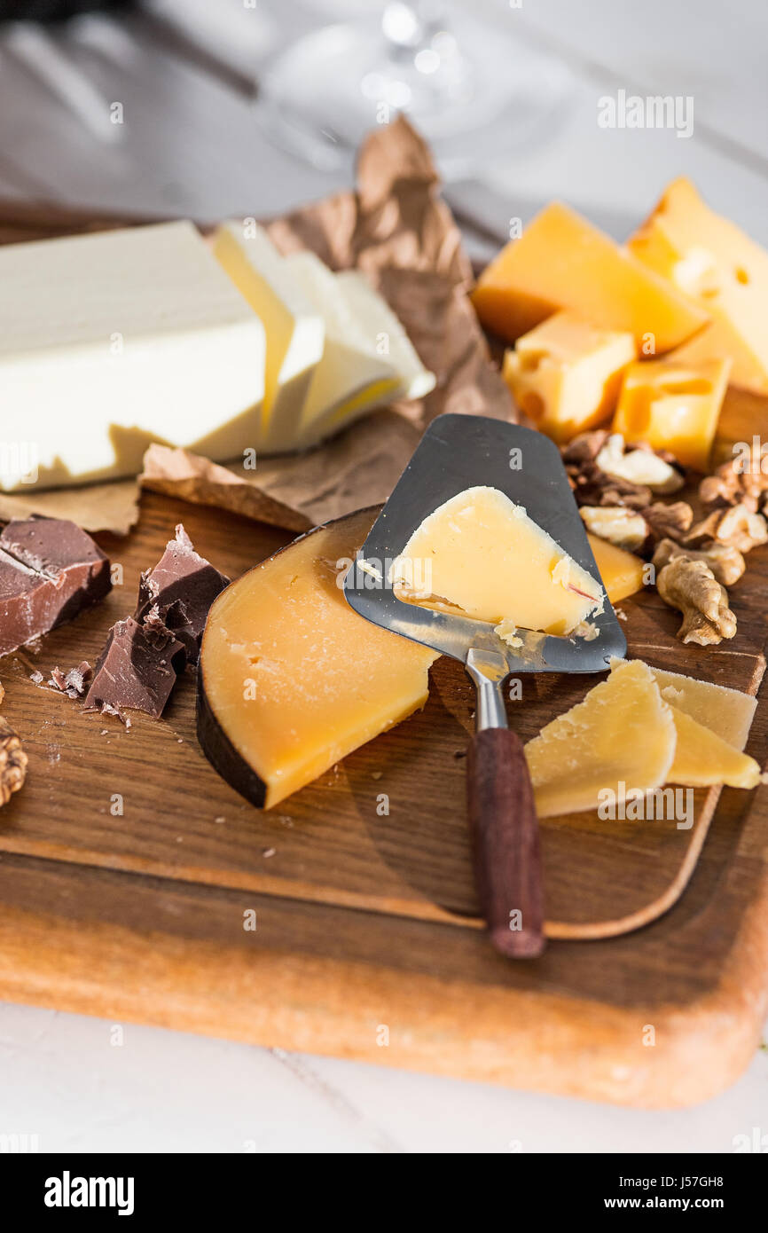 The different kind of cheese and walnuts on wooden background Stock ...