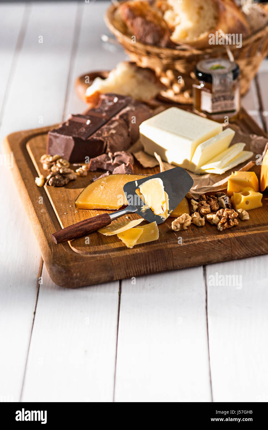 The different kind of cheese and walnuts on wooden background Stock ...