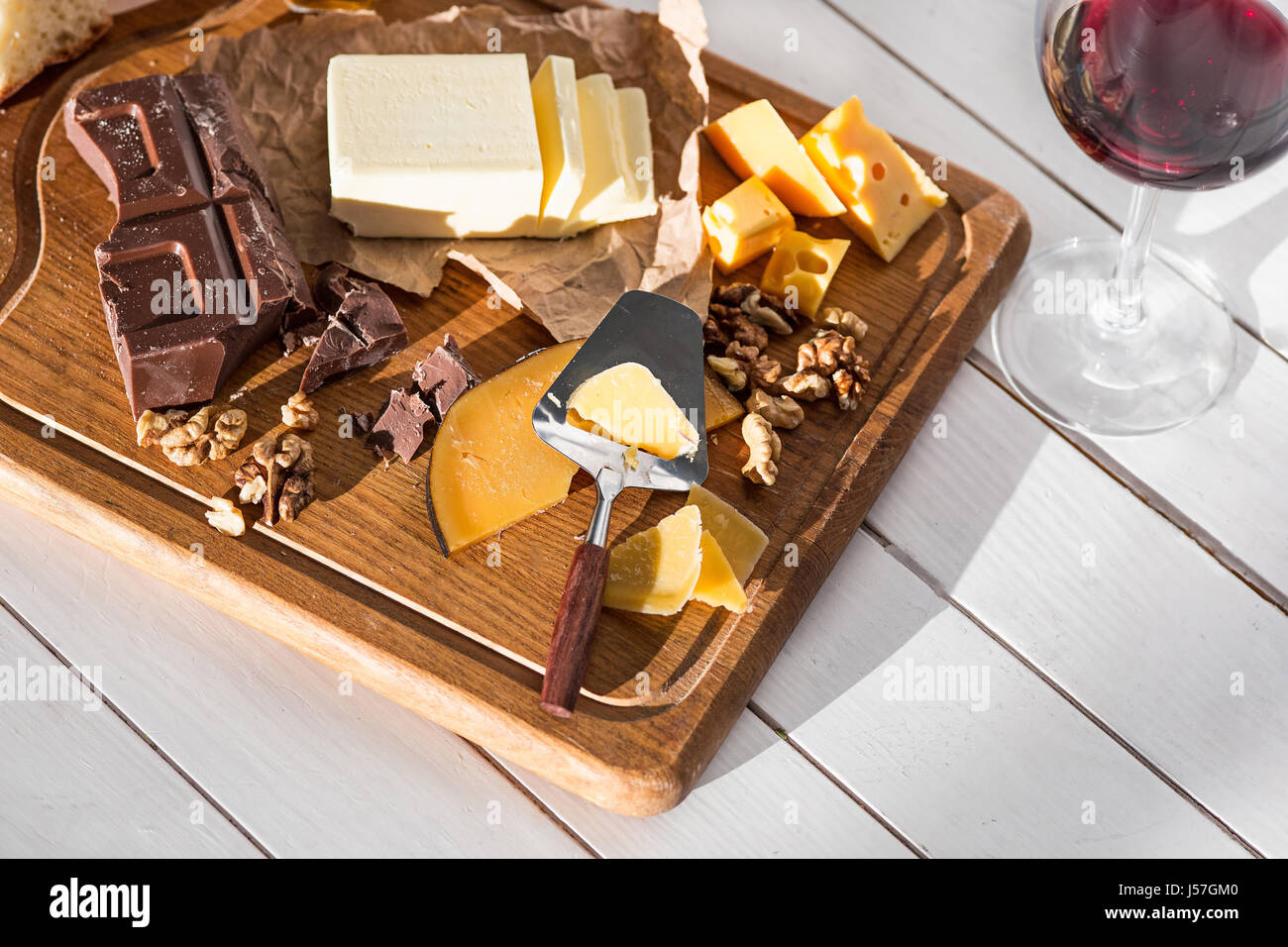 The different kind of cheese and walnuts on wooden table background ...