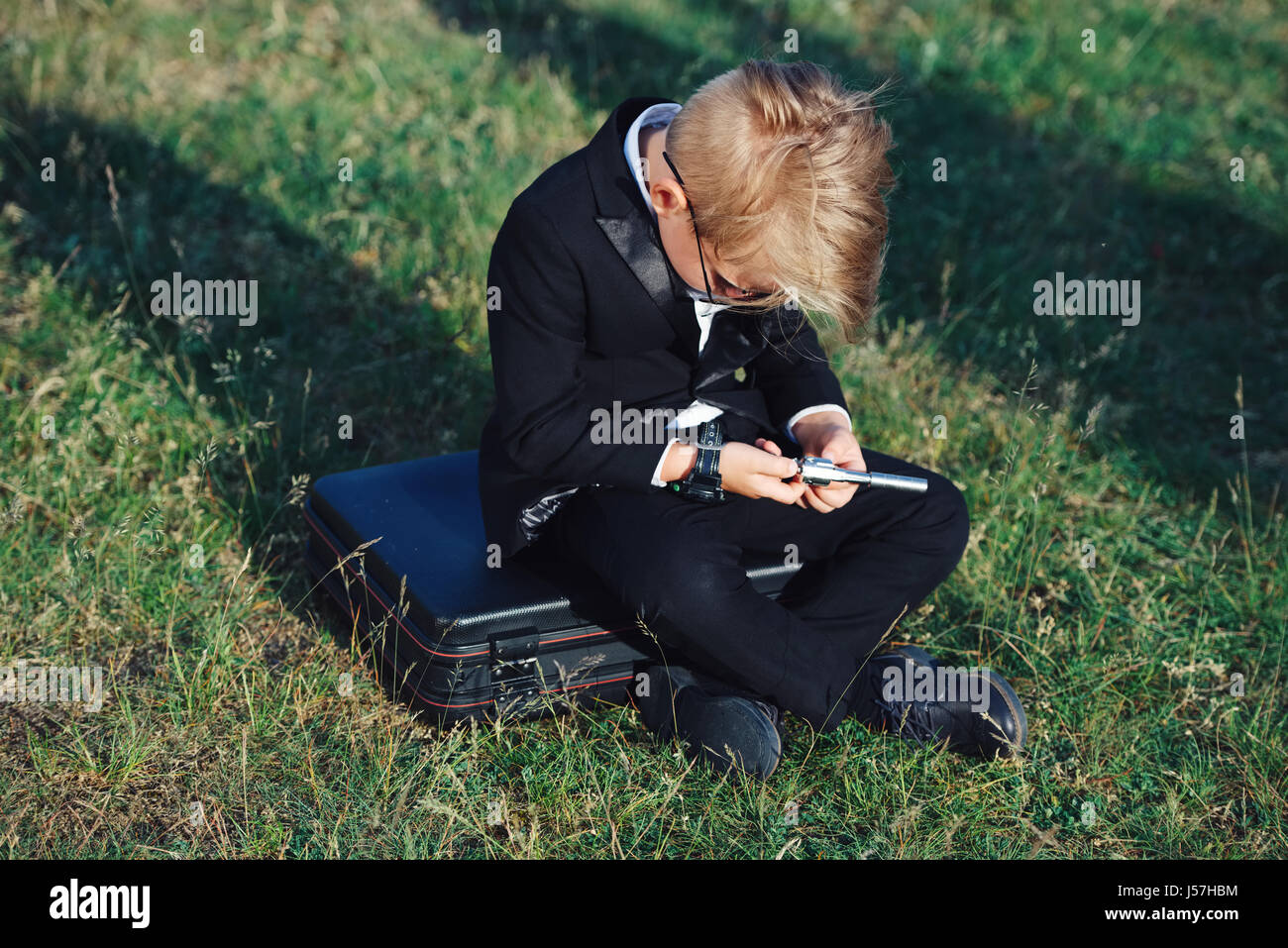 photo of little boy playing secret agent Stock Photo - Alamy