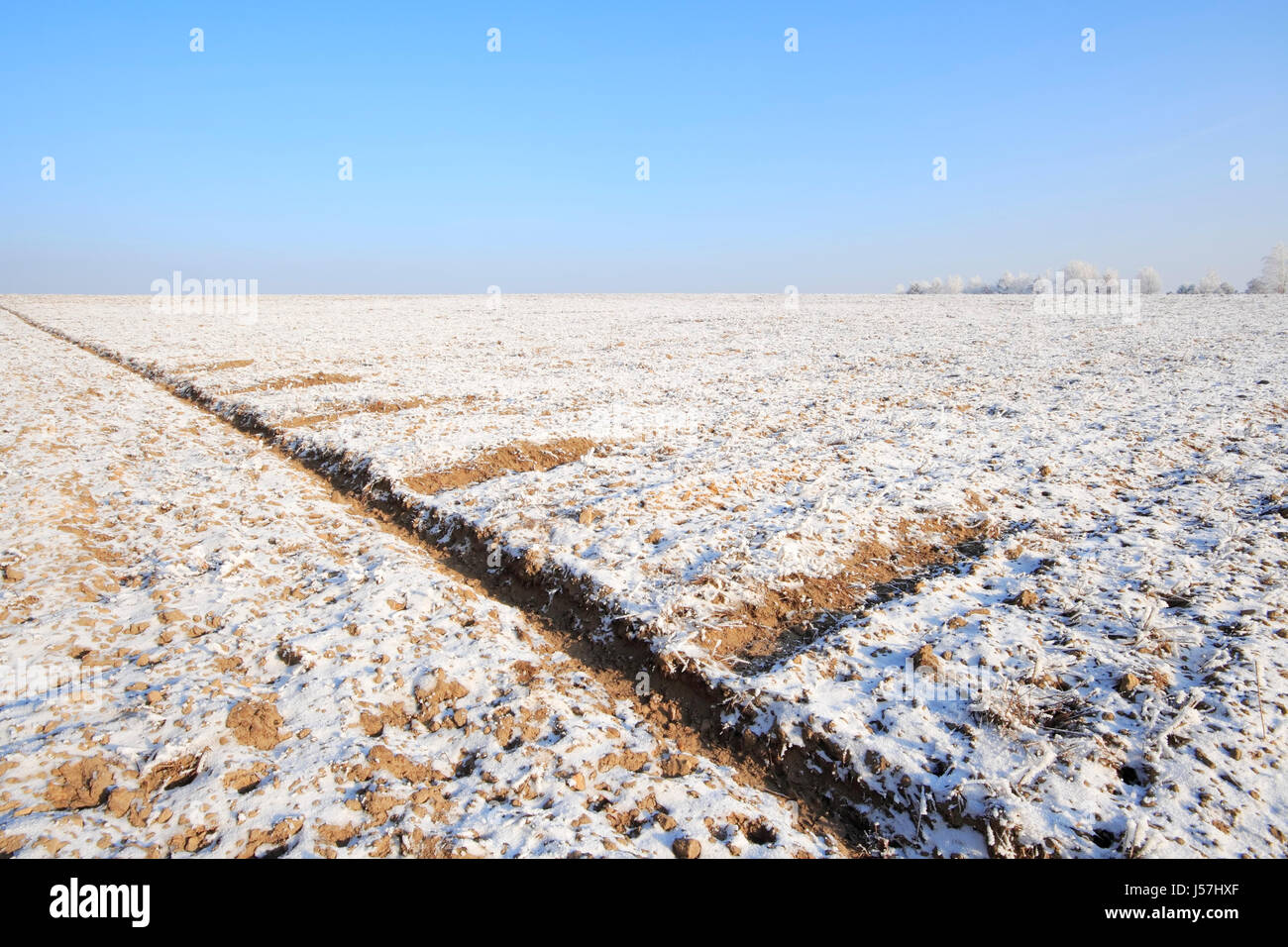 Flat fields in winter covered by thin snow layer. Poland ...