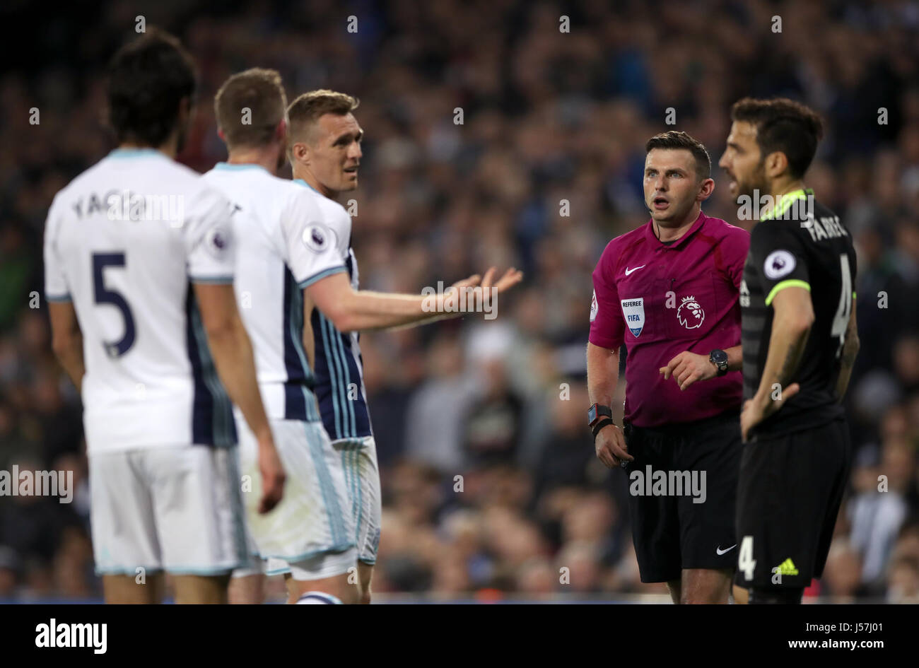 Referee Michael Oliver (second from right) tries to calm down a ...