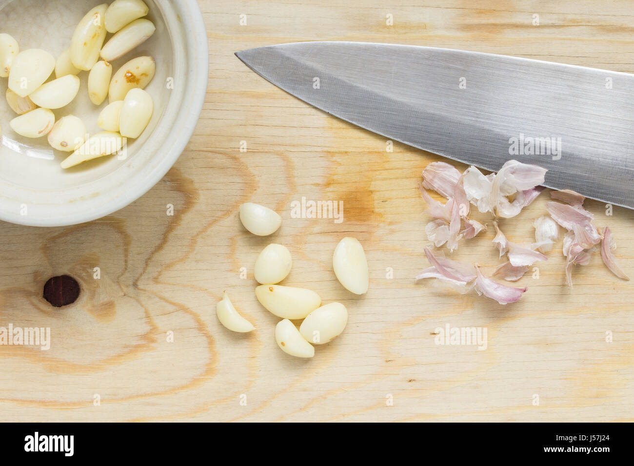 Peel garlic with sharp knife Stock Photo - Alamy
