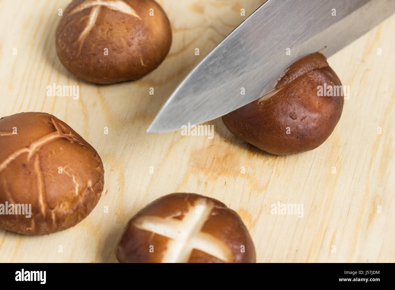Sharp knife cut some part of mushroom for decoration Stock Photo - Alamy