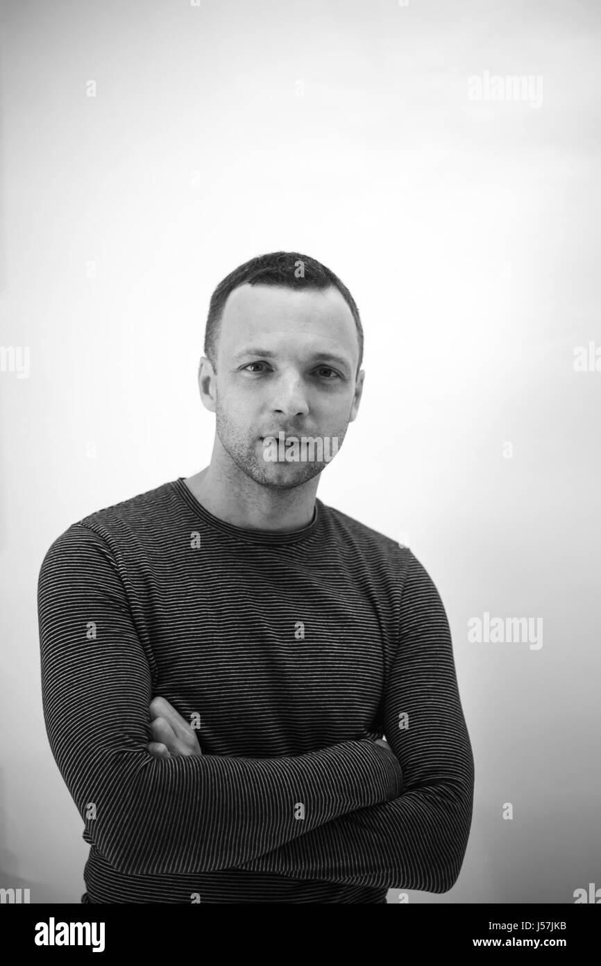 Vertical black and white studio portrait of young adult European man ...