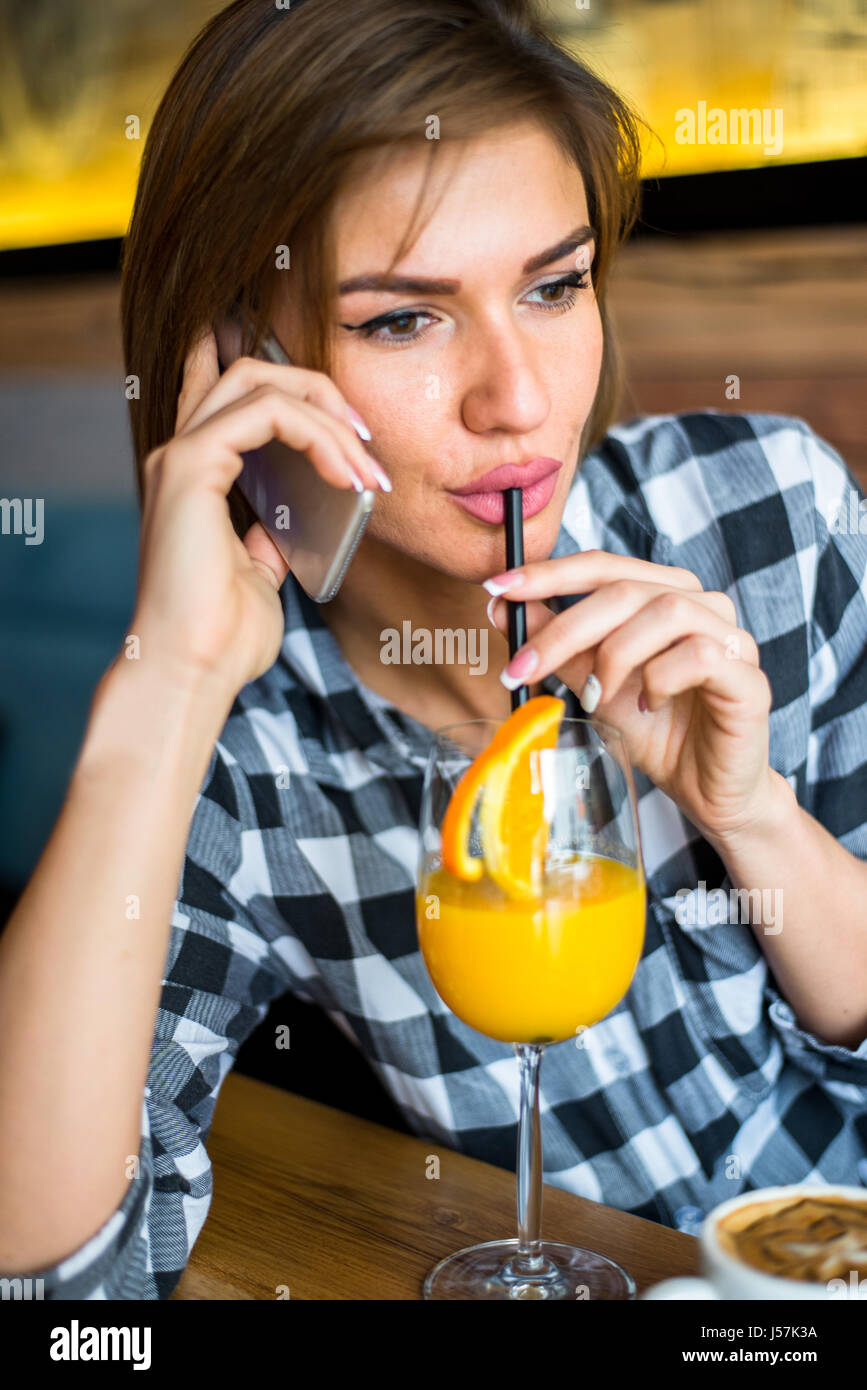 Beautiful young woman using cell telephone while enjoying her free time ...