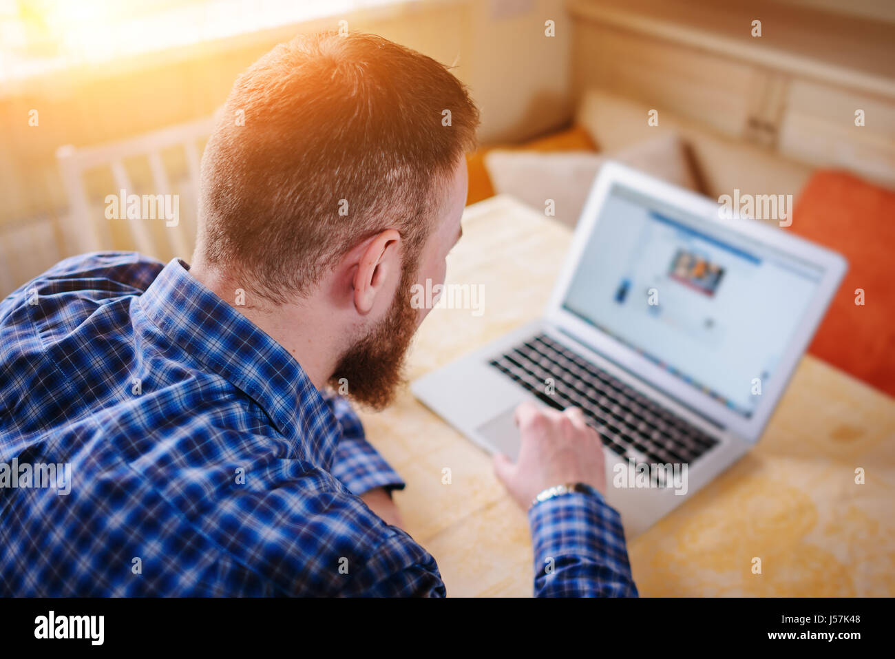 businessman using laptop at workplace - rear view Stock Photo - Alamy