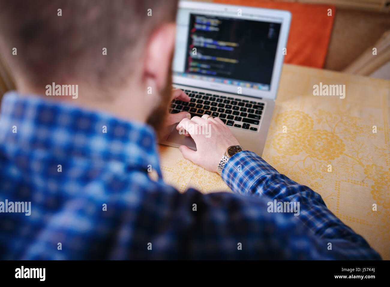businessman using laptop at workplace - rear view Stock Photo - Alamy