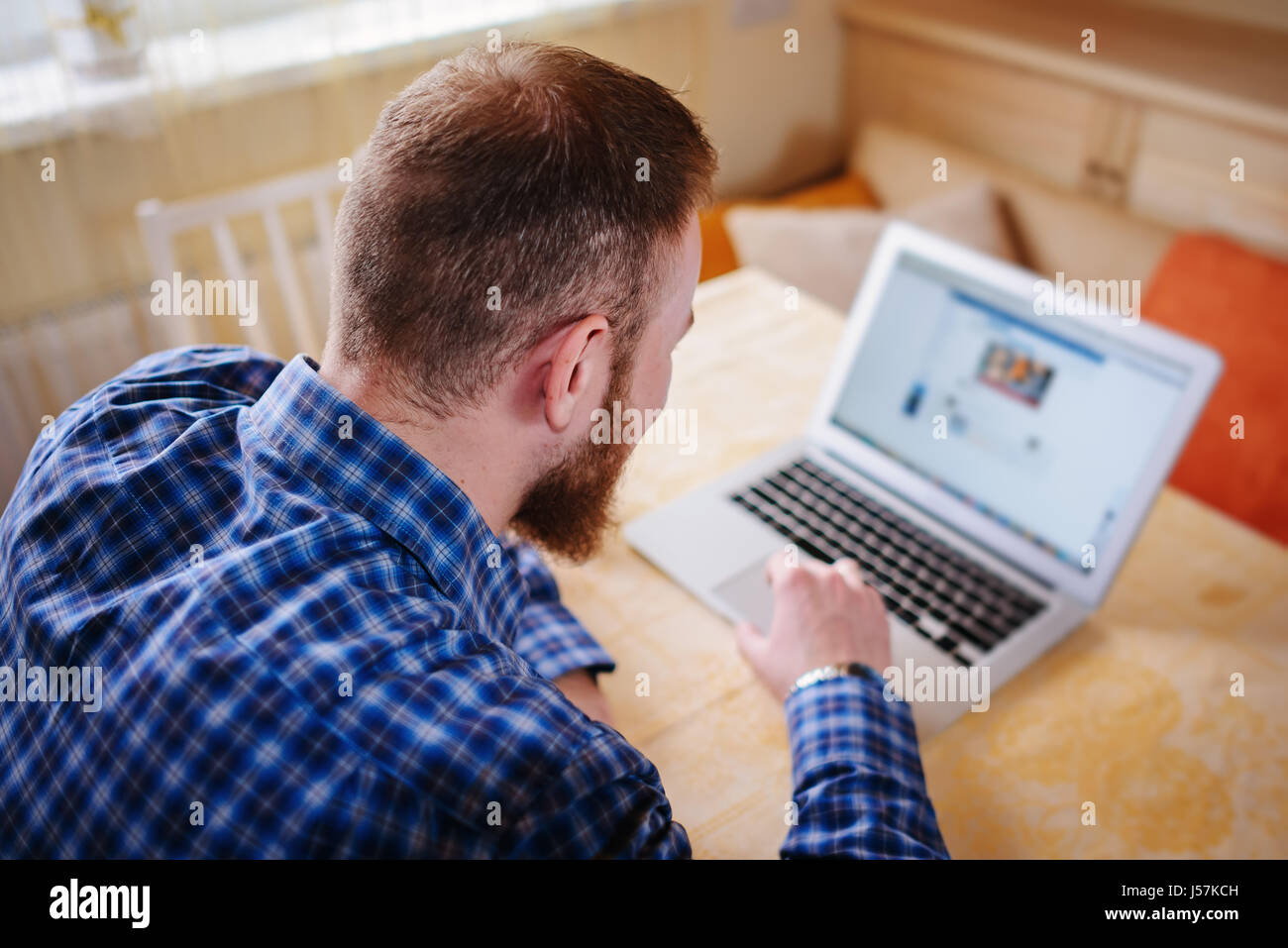 businessman using laptop at workplace - rear view Stock Photo - Alamy