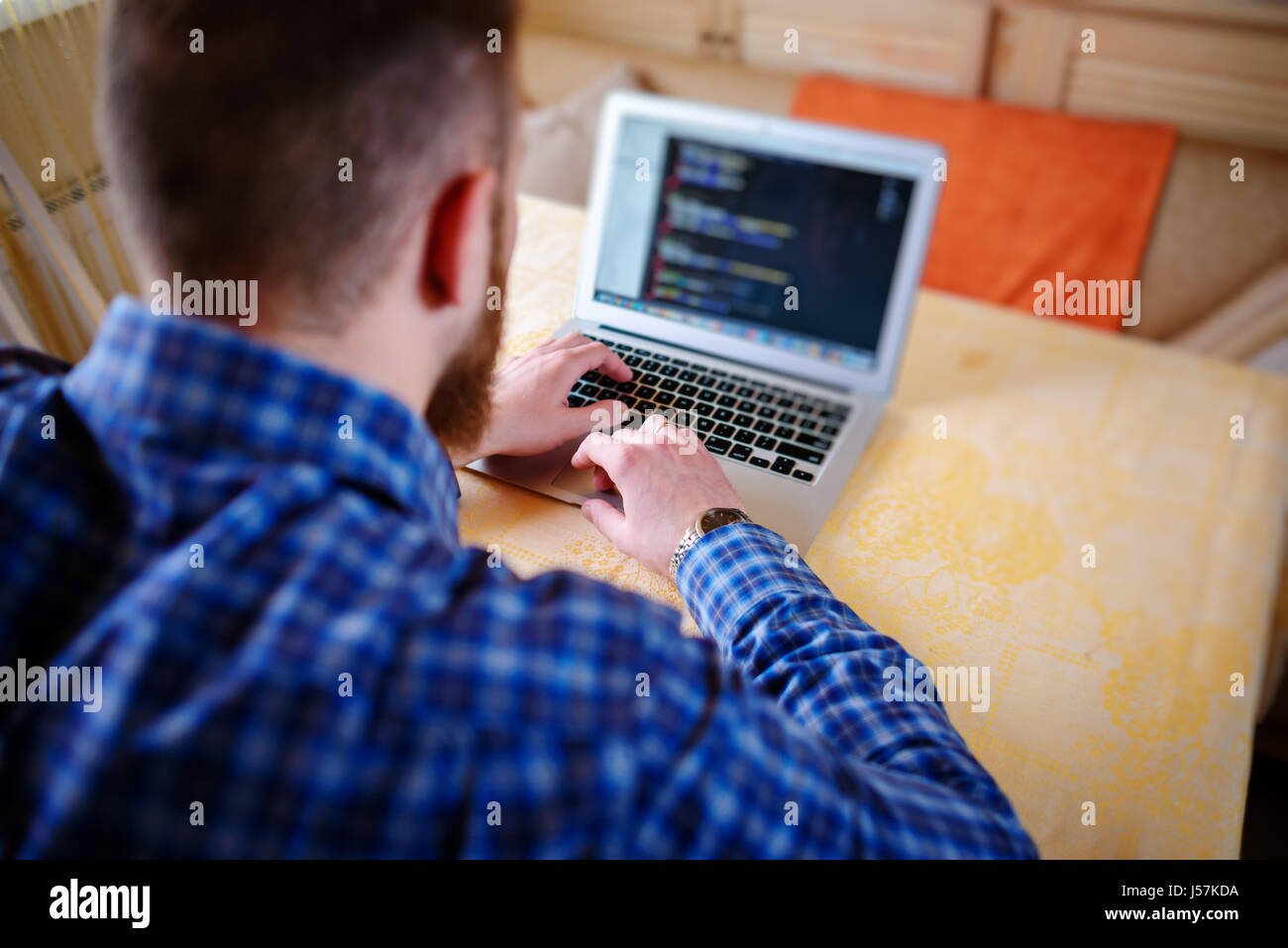 businessman using laptop at workplace - rear view Stock Photo - Alamy