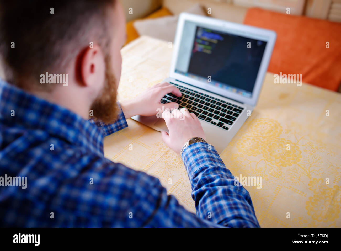 businessman using laptop at workplace - rear view Stock Photo - Alamy
