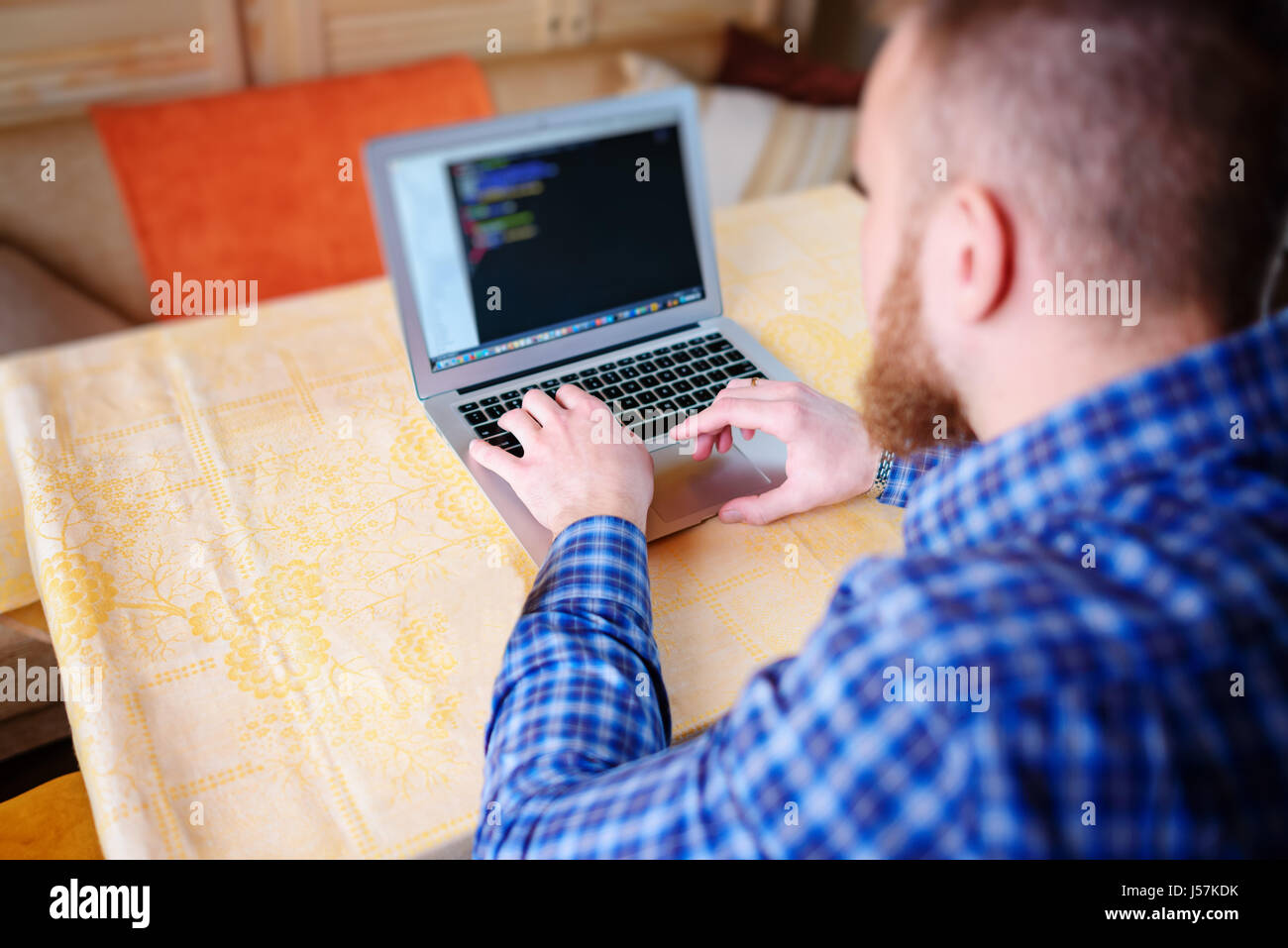 businessman using laptop at workplace - rear view Stock Photo - Alamy