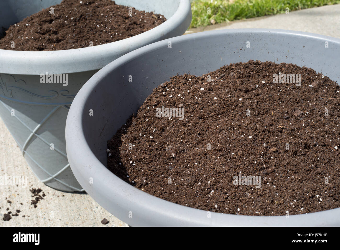 Plant containers containing potting soi Stock Photo - Alamy