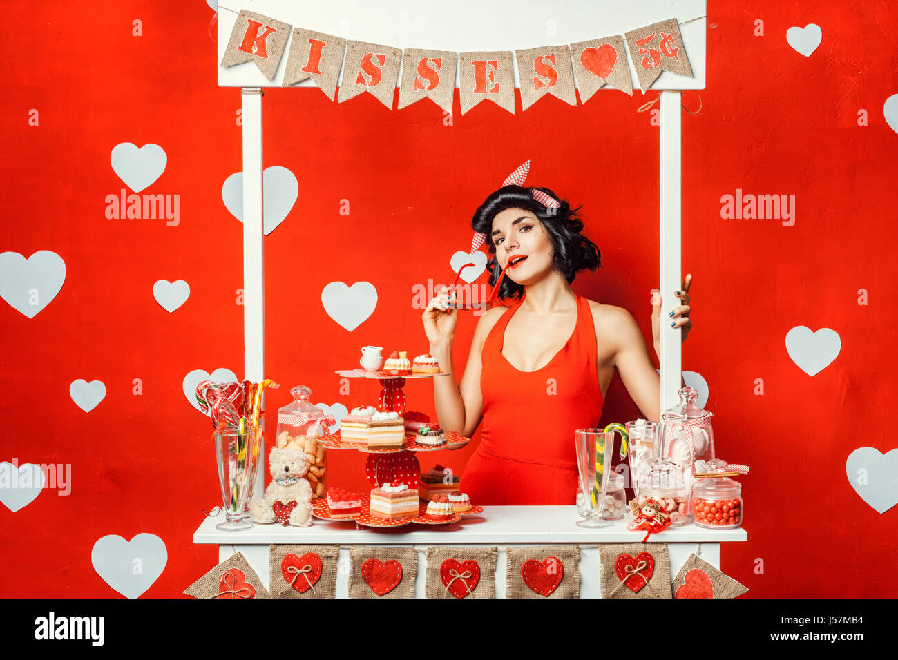 Girl standing in a booth with sweets and cakes in retro style Stock ...