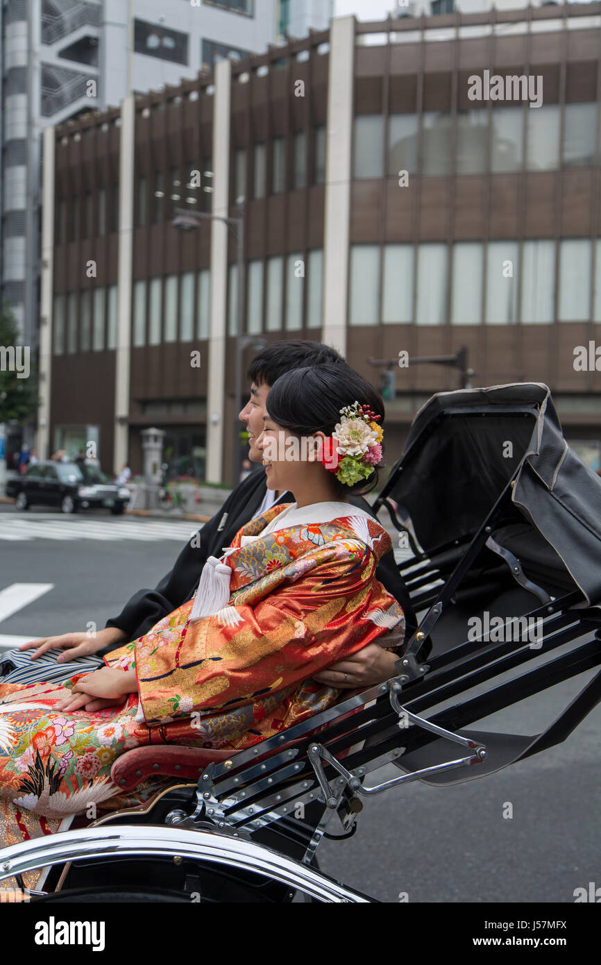 TOKYO, JAPAN - OCTOBER 3, 2016: Unidentified people riding on rickshaw ...