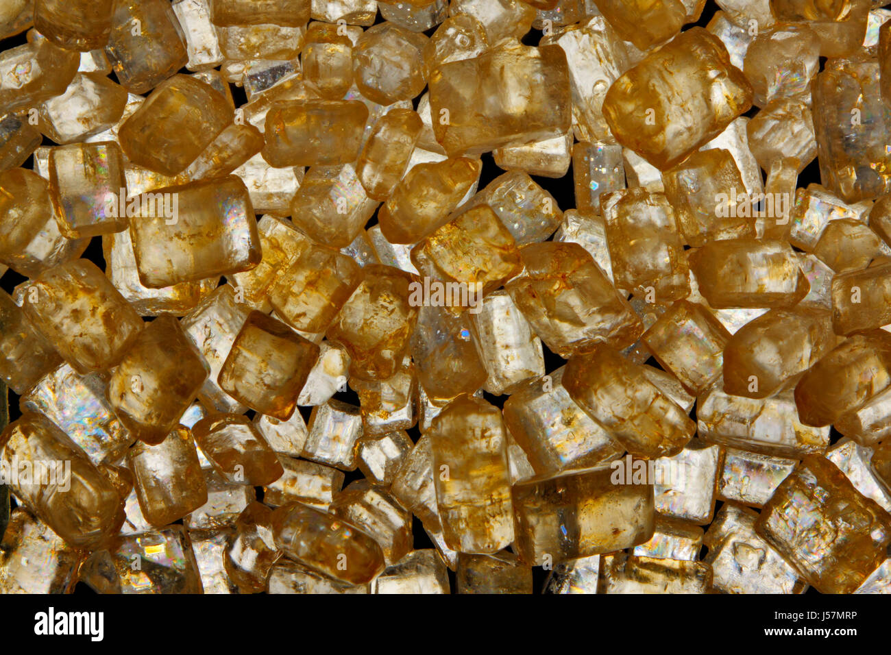 Brown cane sugar crystals close up. Full frame shoot. Polarized light ...