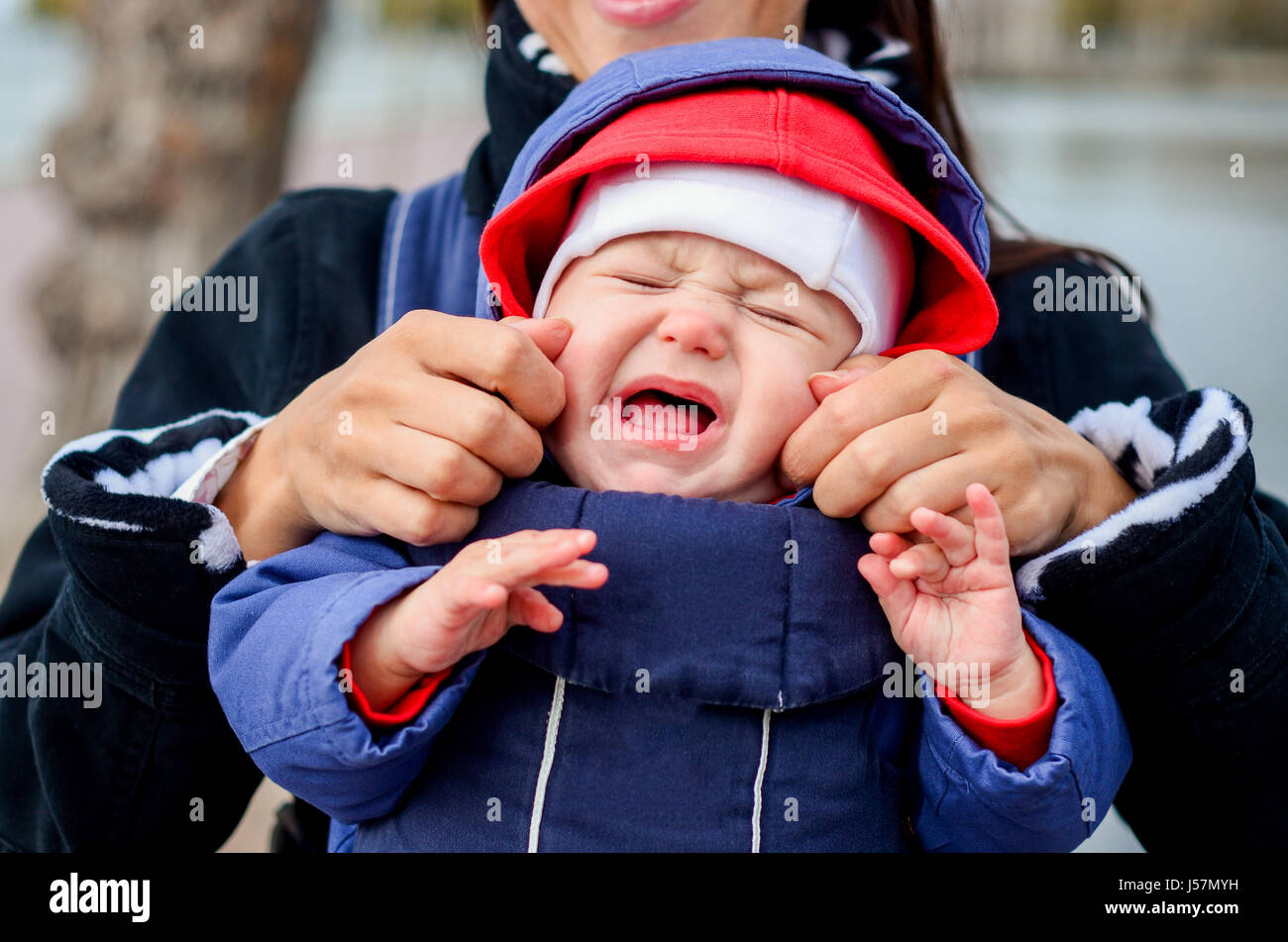 Little baby crying in the park, fall season Stock Photo - Alamy