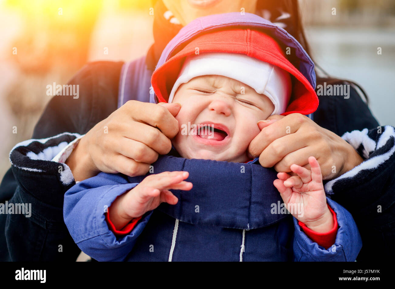 Little baby crying in the park, fall season Stock Photo - Alamy