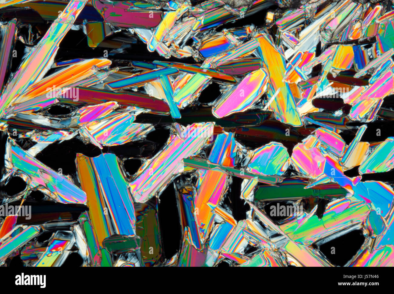 Microscopic view of colorful potassium nitrate crystals. Polarized ...