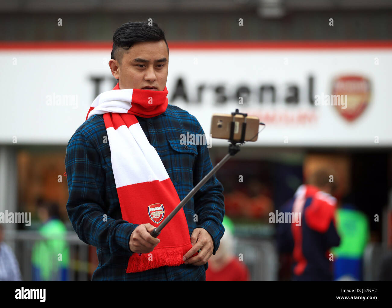 An Arsenal fan takes a selfie before the Premier League match at the ...