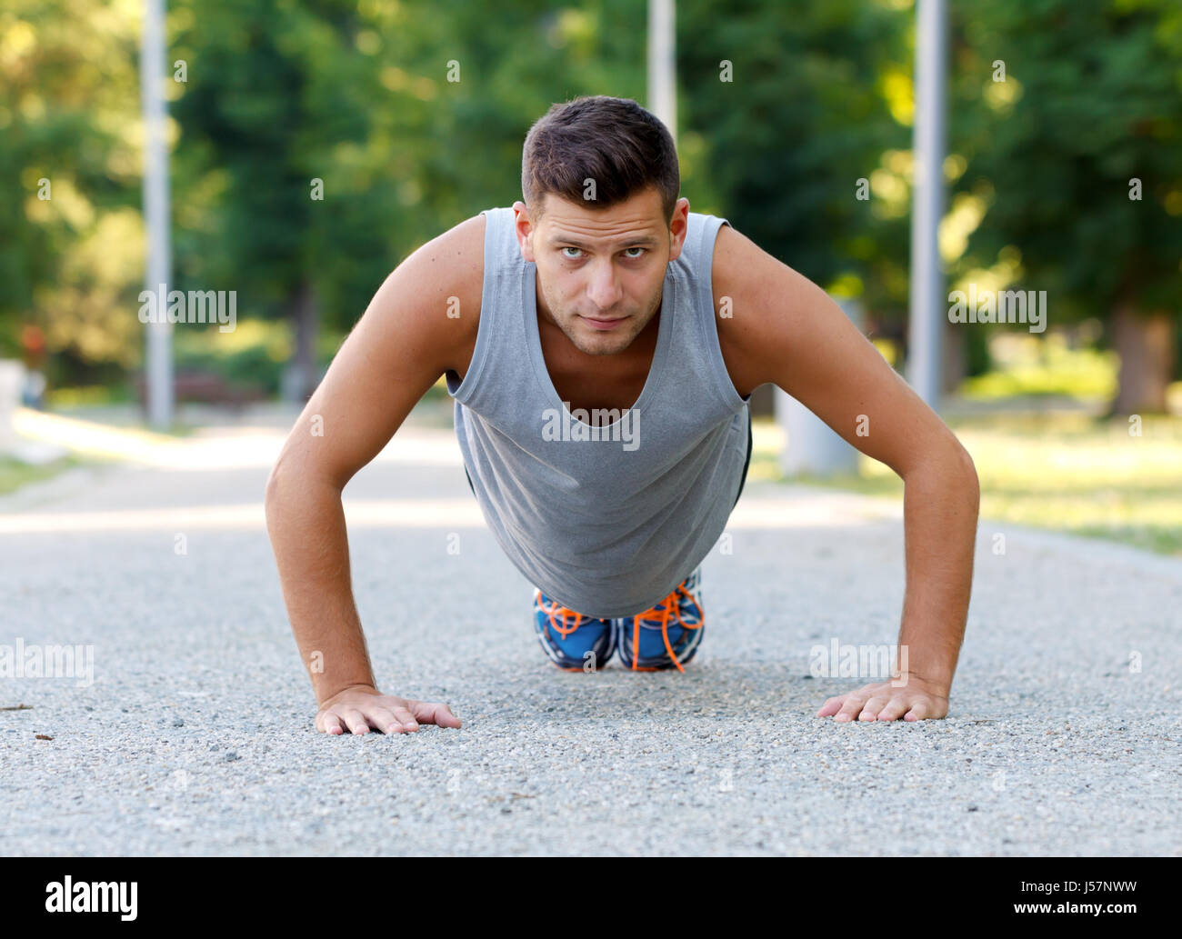 Young athlete male doing push ups outdoor Stock Photo - Alamy