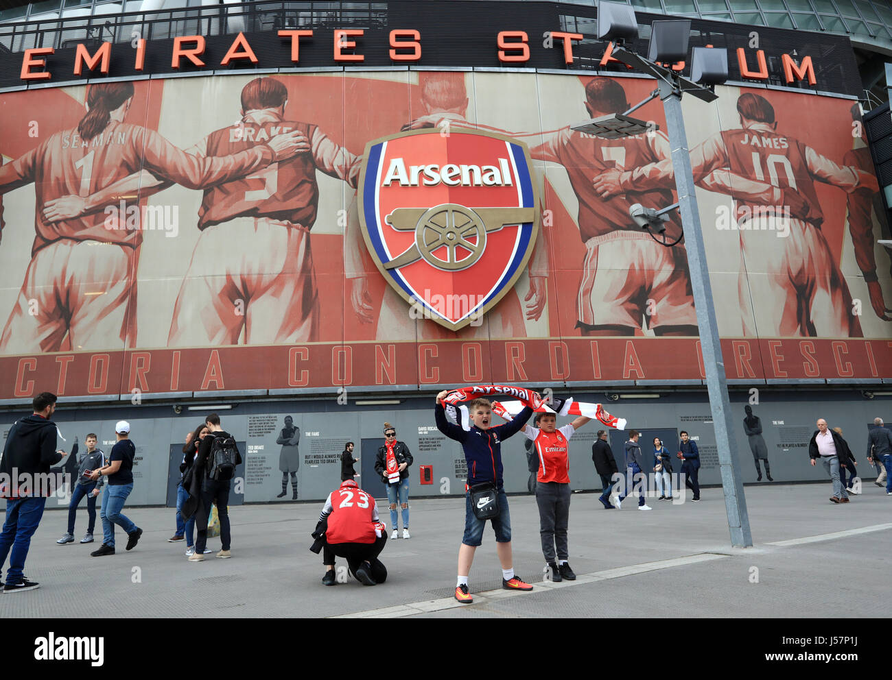 Arsenal fans pose for a picture before the Premier League match at the ...