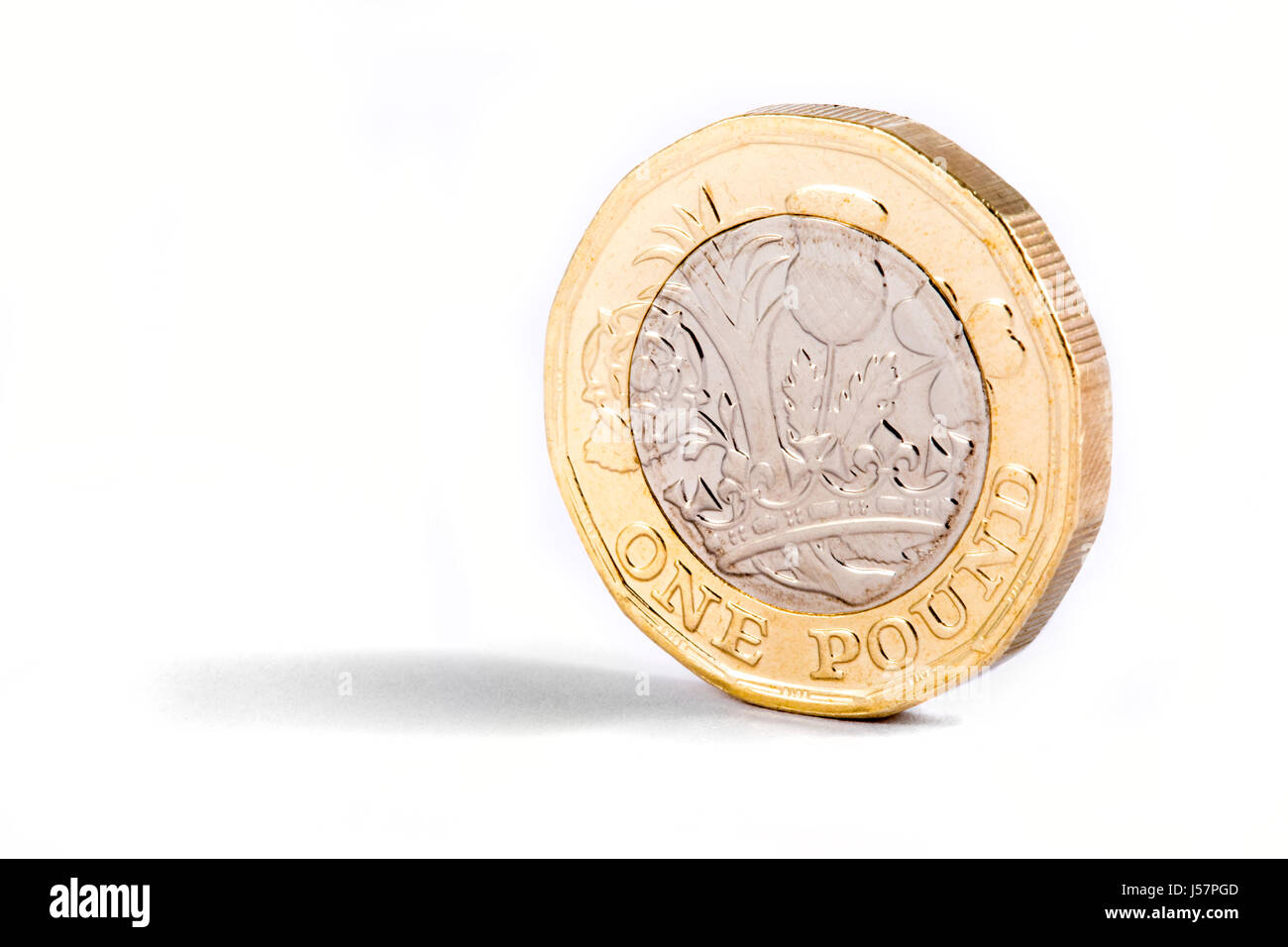 A close-up shot of the new British one pound coin over a white ...