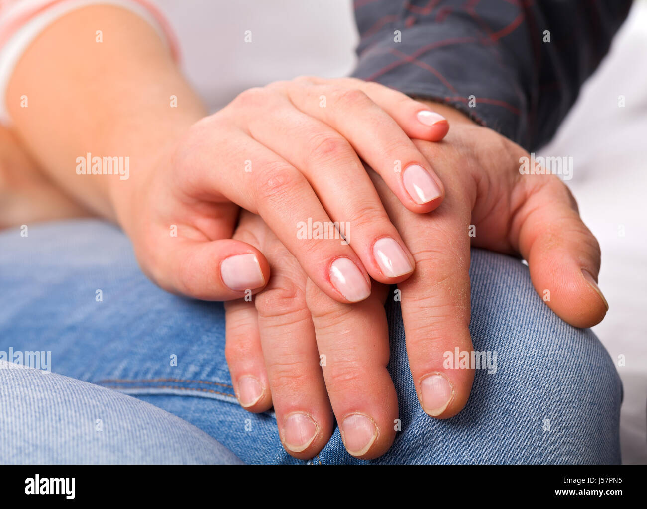 Female caregiver touching her hopeless patient's hand Stock Photo - Alamy