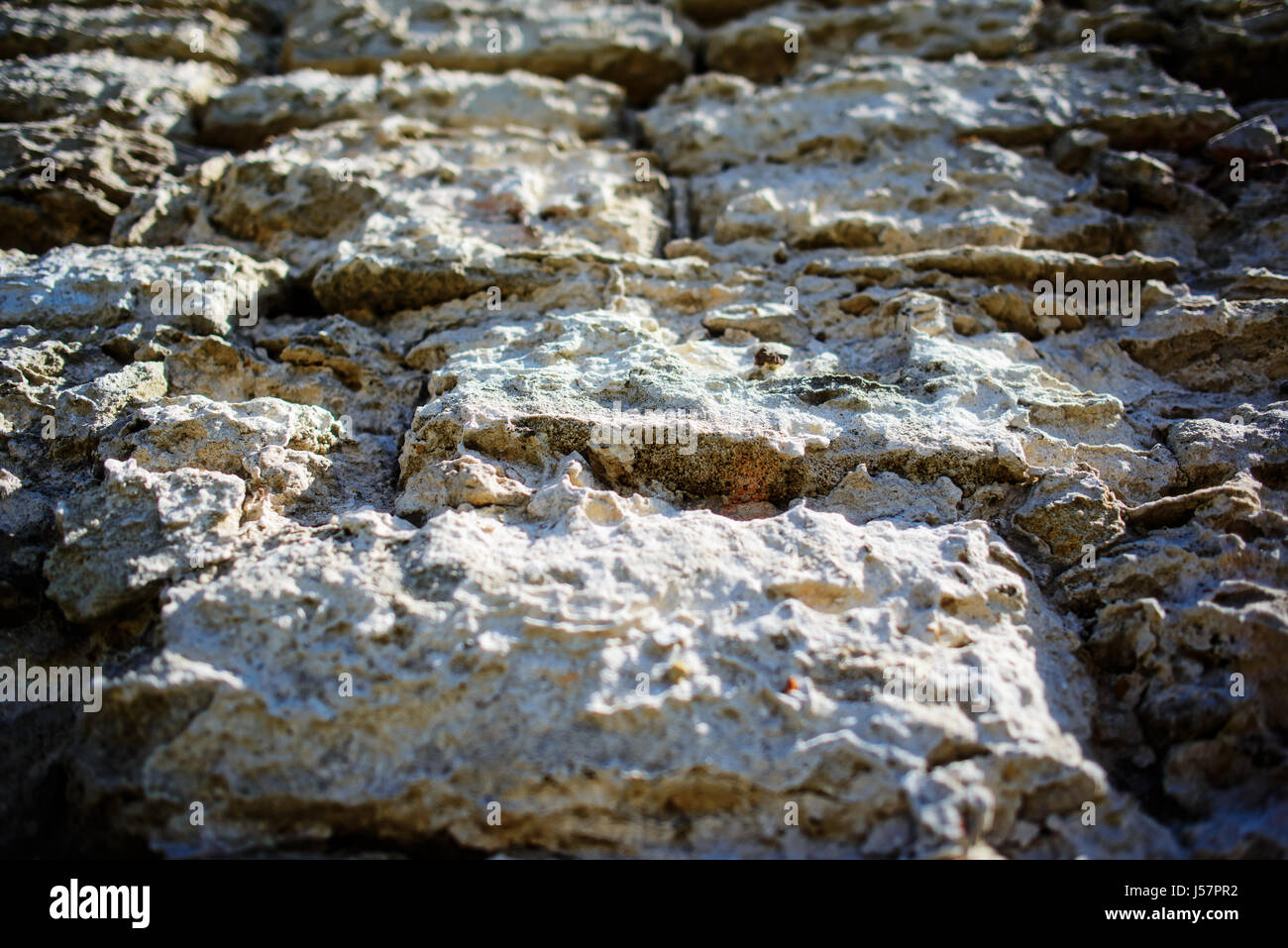 old wall of stone bricks textured background Stock Photo - Alamy