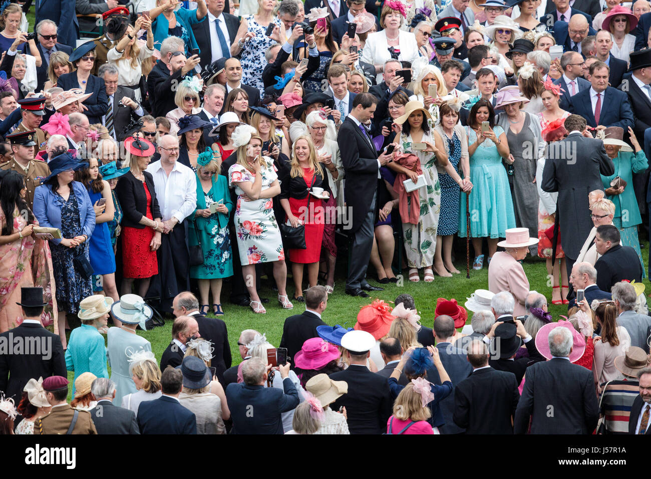 Queen Elizabeth II (centre right) greets guests at a garden party at ...