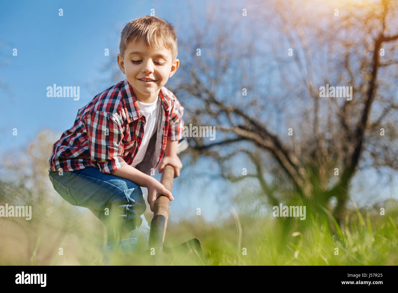 Adorable boy digging soil in spring Stock Photo - Alamy