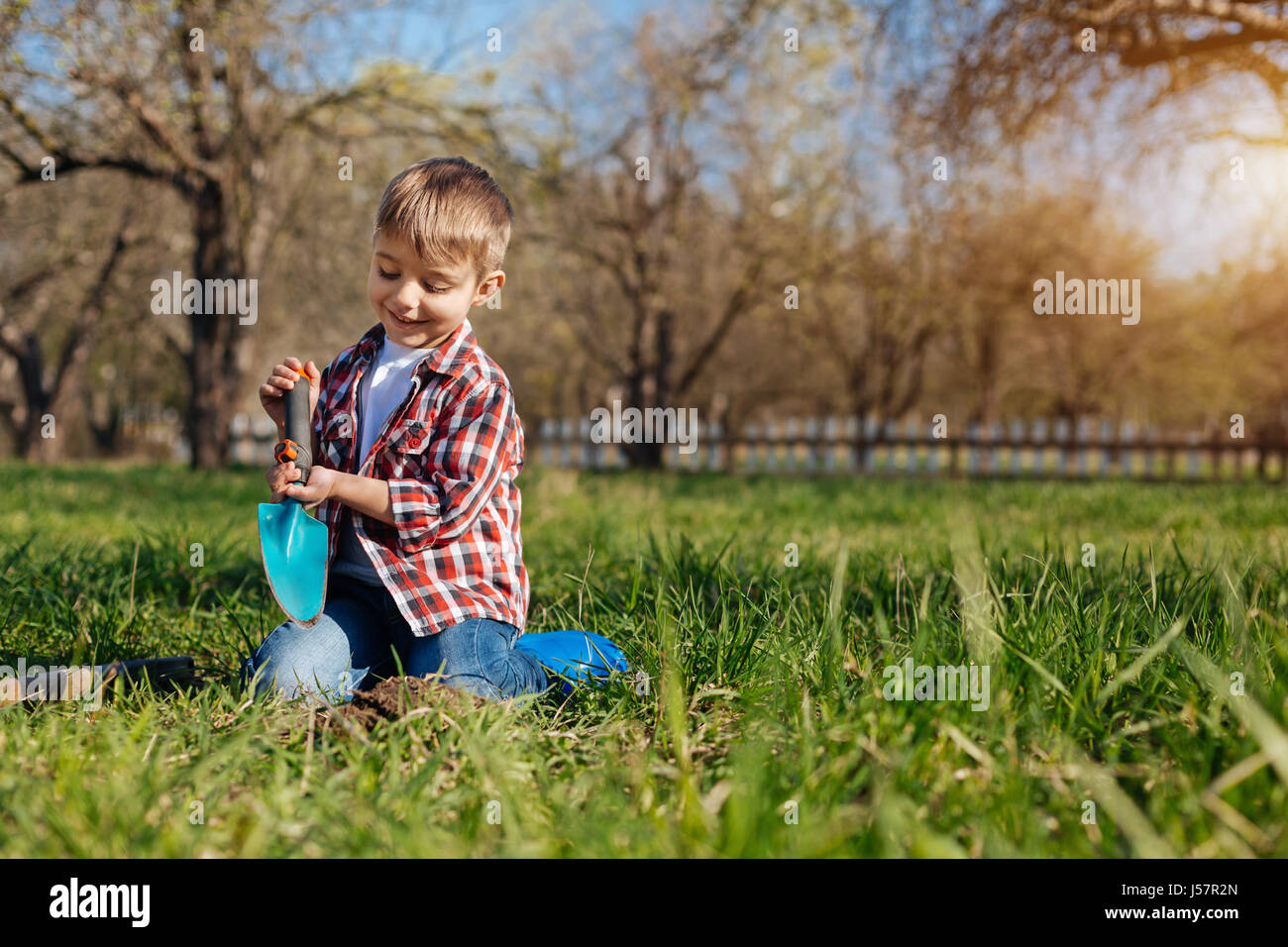Child scooping soil hi-res stock photography and images - Alamy